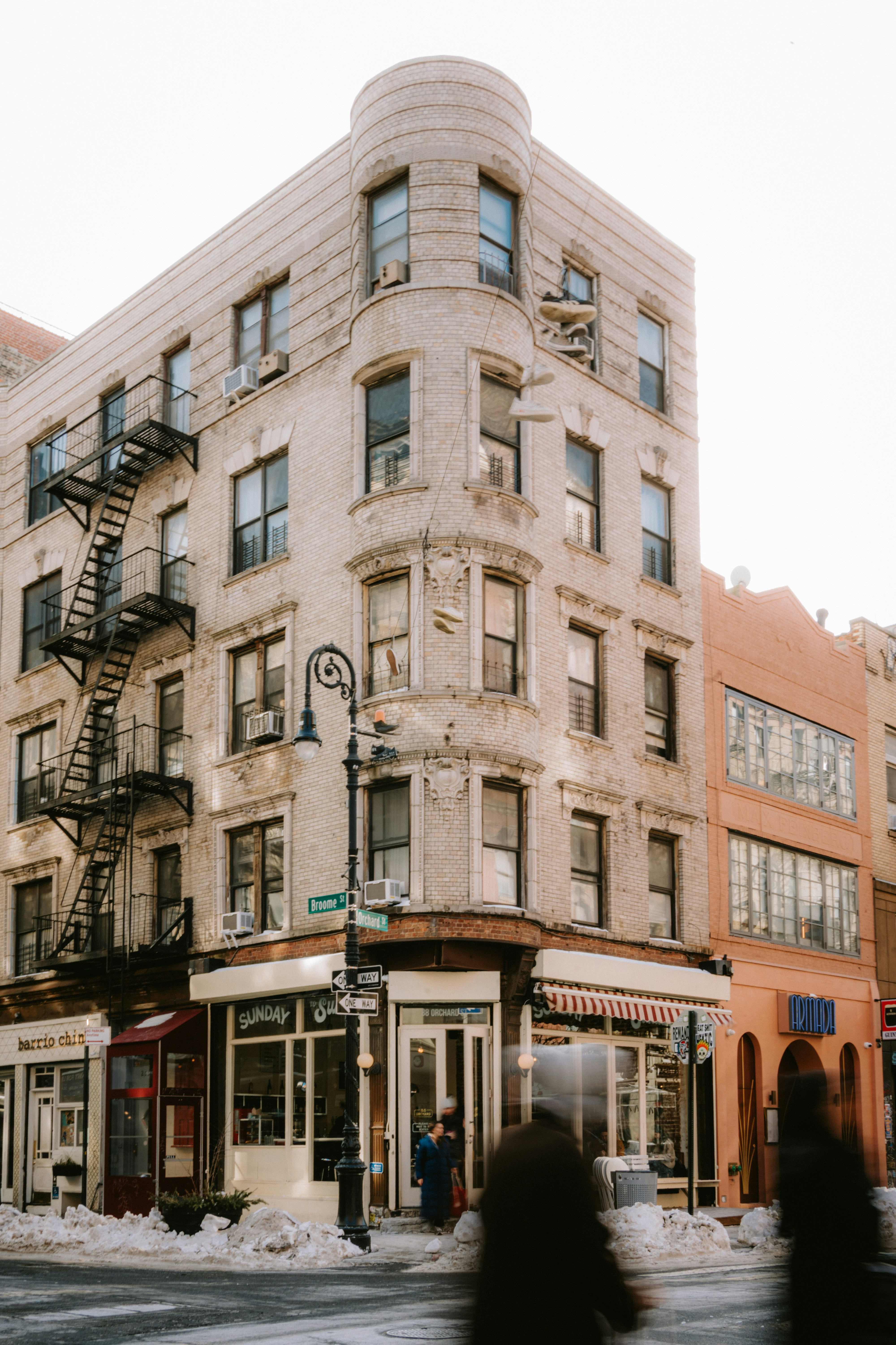 Cornered Echoes: A Weathered Urban Facade Framed by Passing Quiet