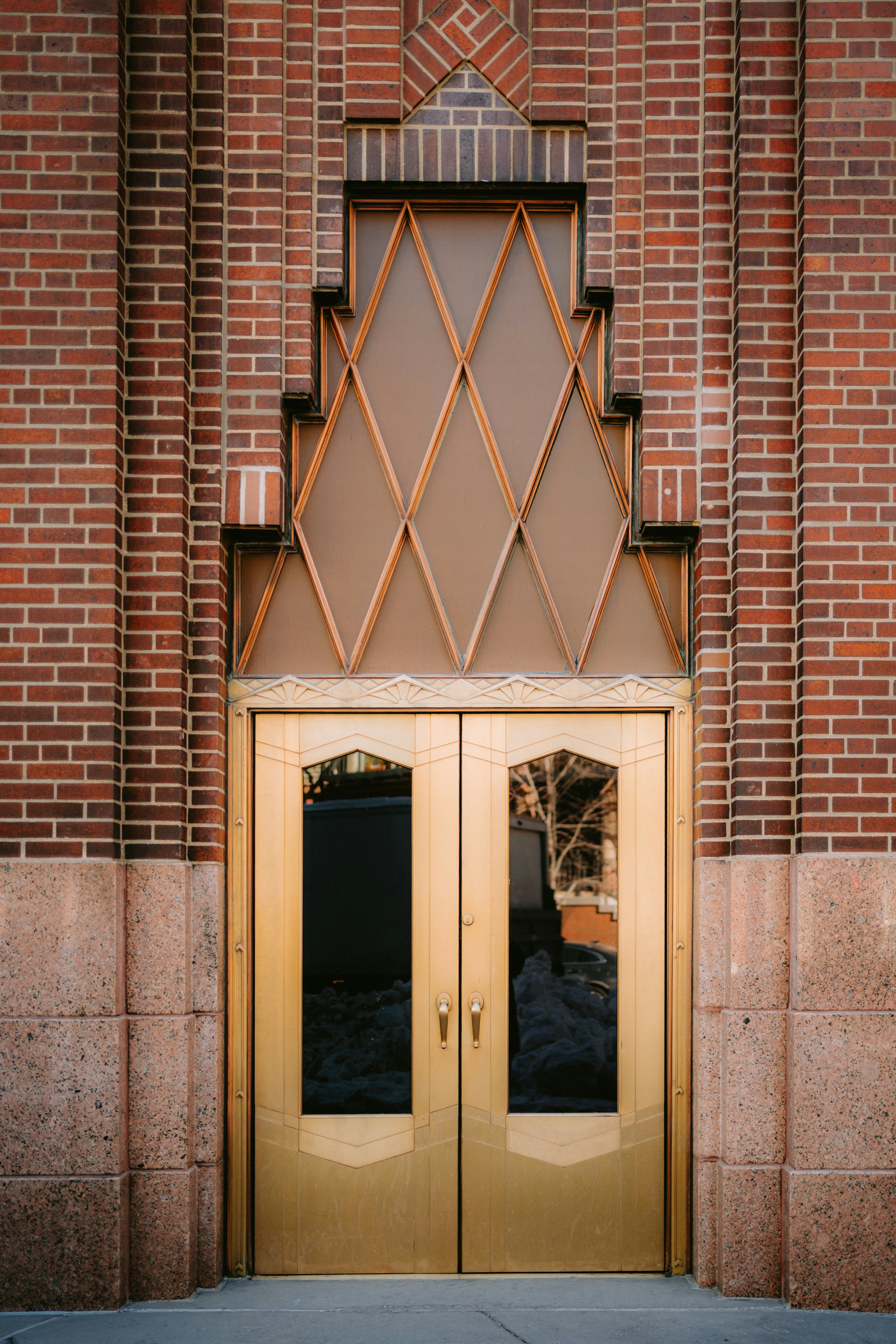 Entrance in a Tall Brick Facade with Diamond Window Grille