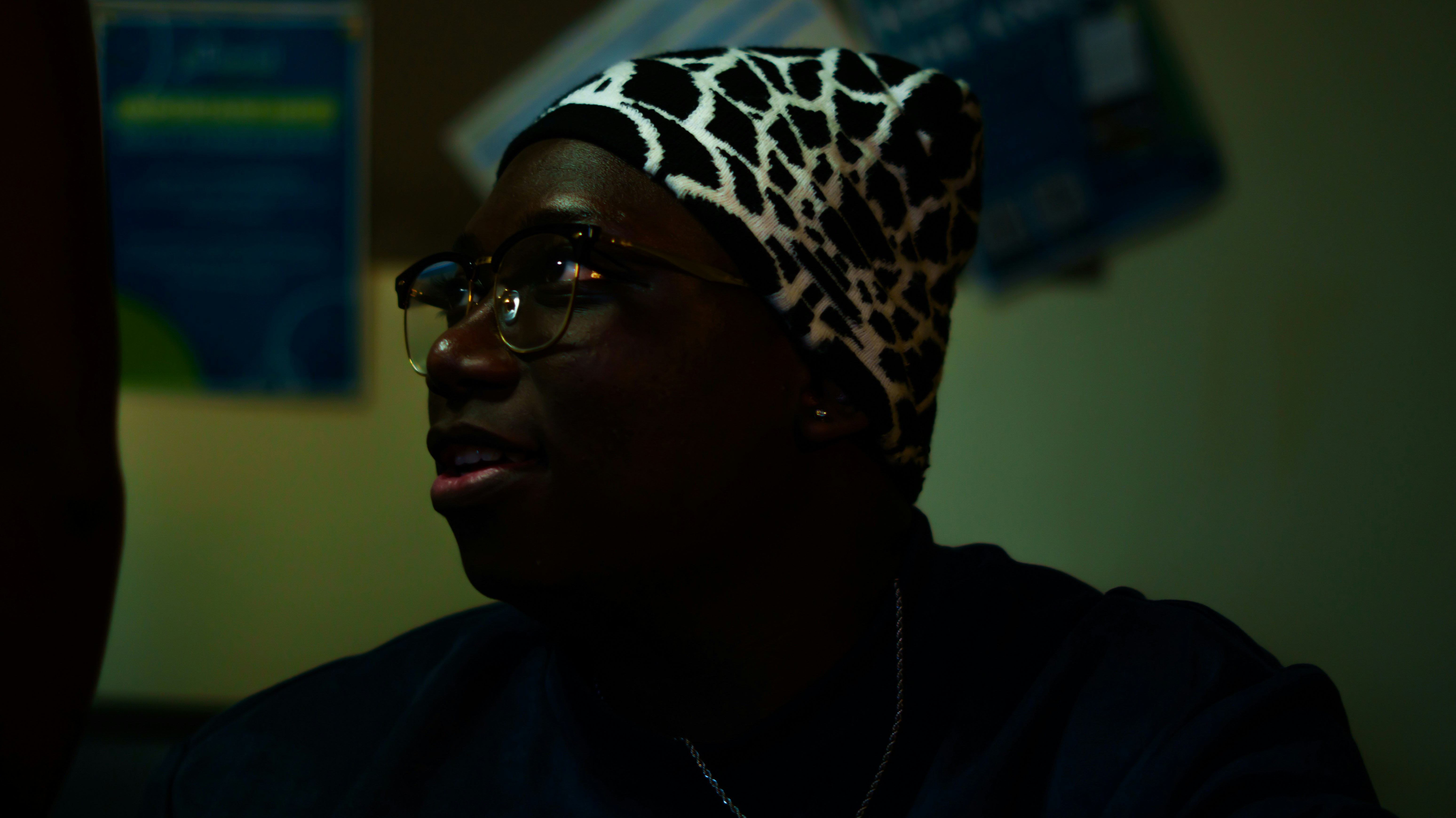 Dimly Lit Portrait: A Contemplative Moment in Glass and Fabric