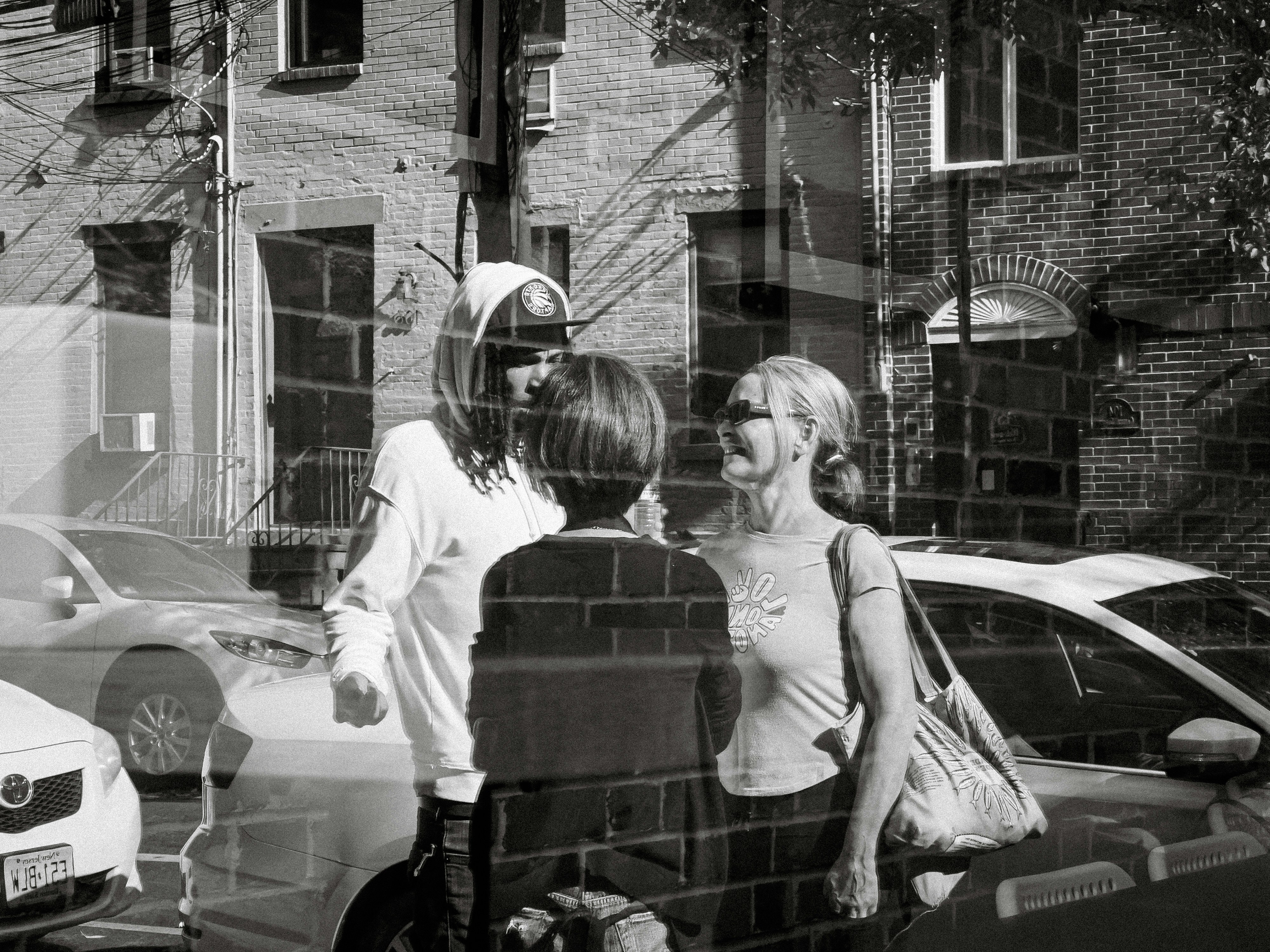 Urban in Conversation: Friends on a Grayscale Street