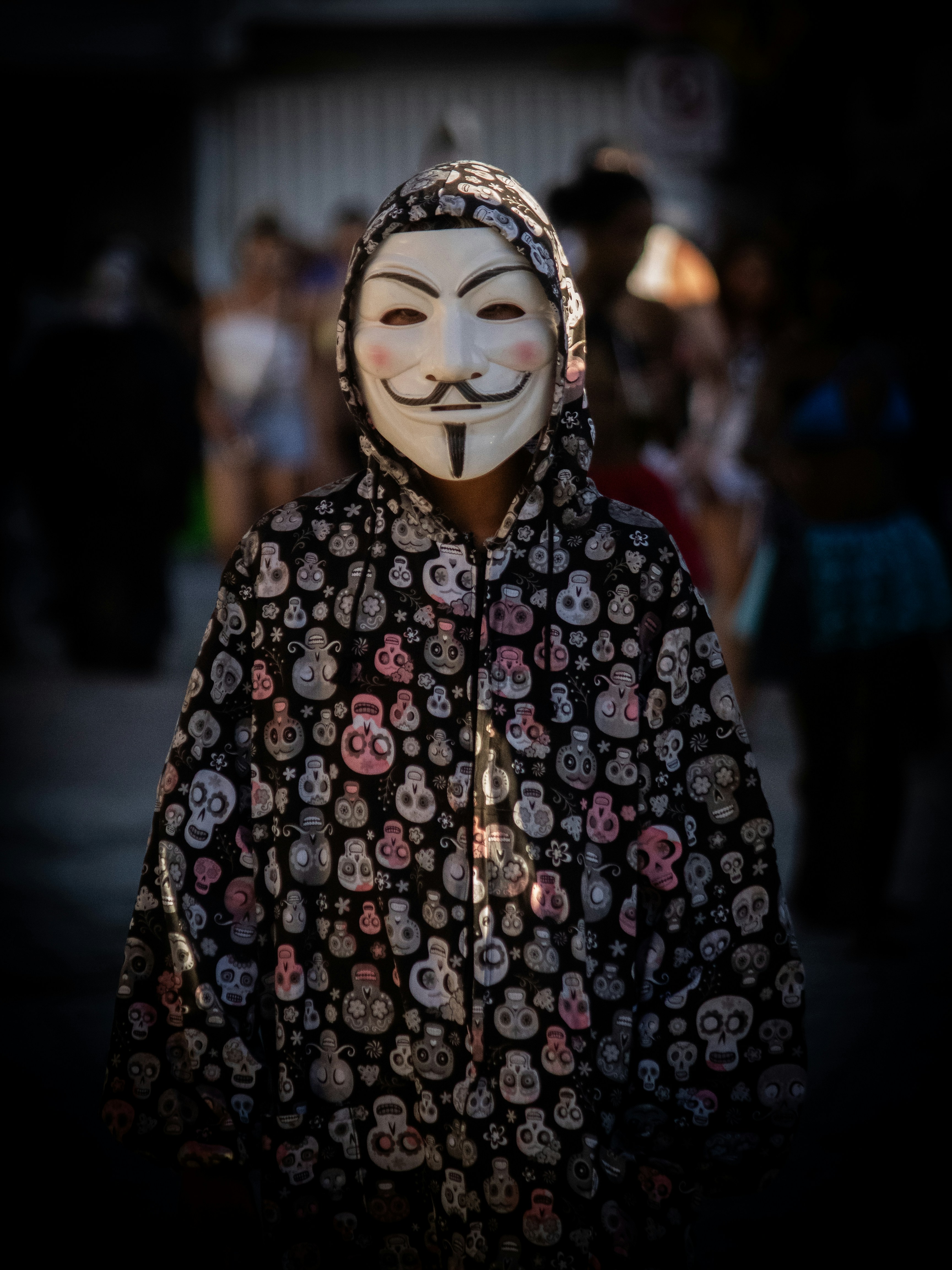 Mask of Mystery in the Crowd: A Casual Stare Beneath a Hoodie