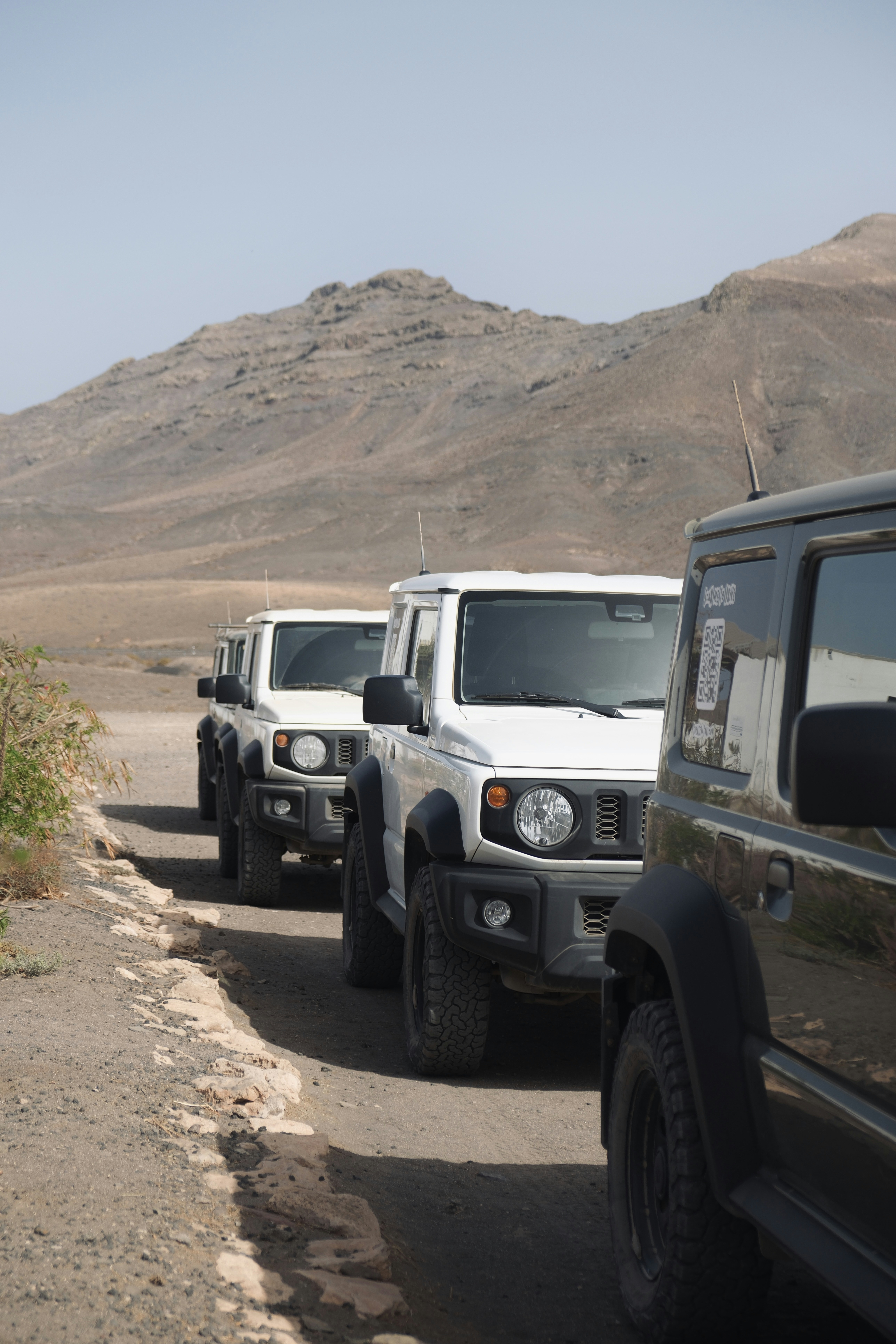 Line of Adventure: Three Jeeps Climb a Desert Road Toward the Distant Ridge