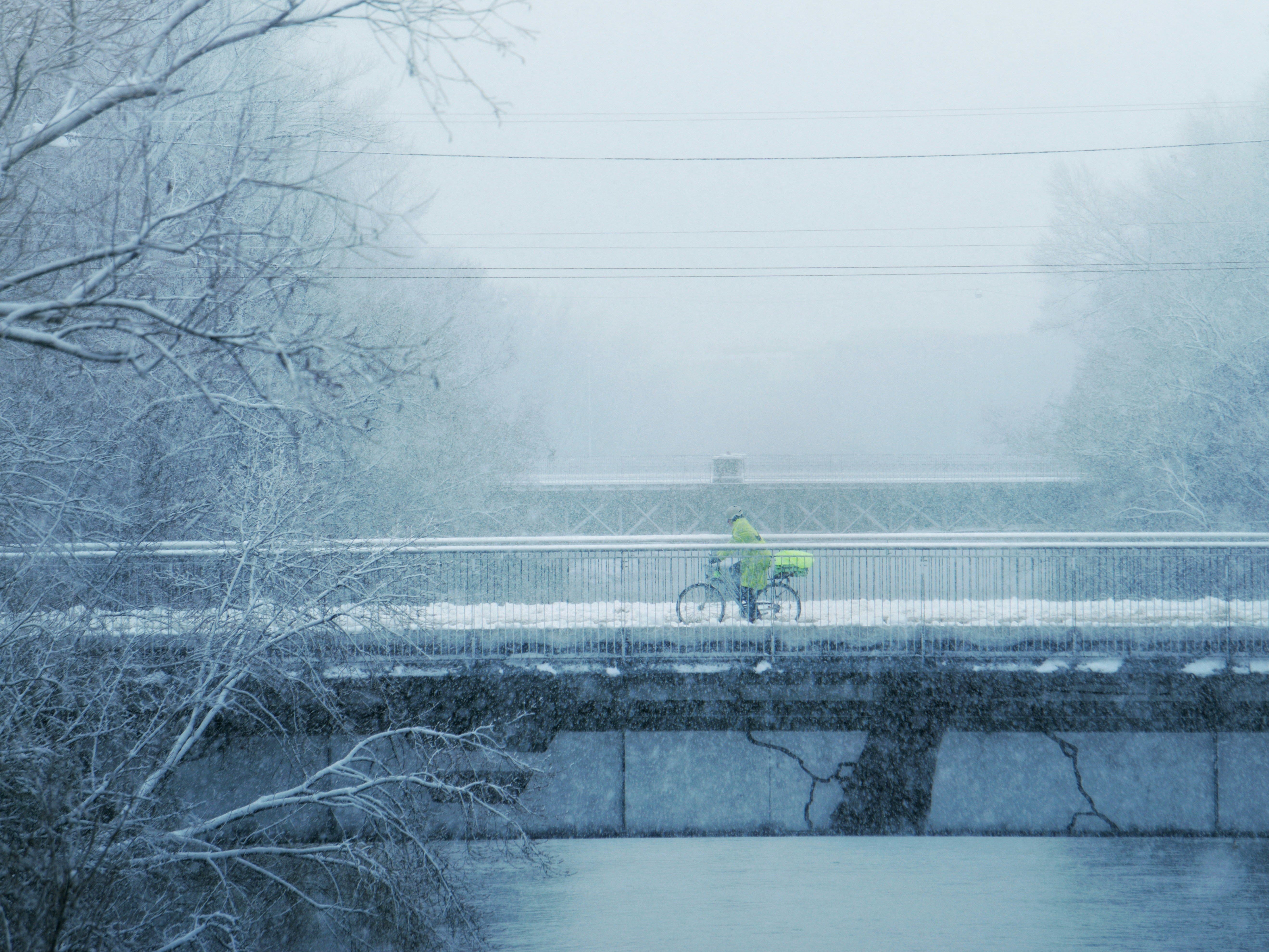 Winter Ride Across a Quiet Snow-Blanketed Bridge
