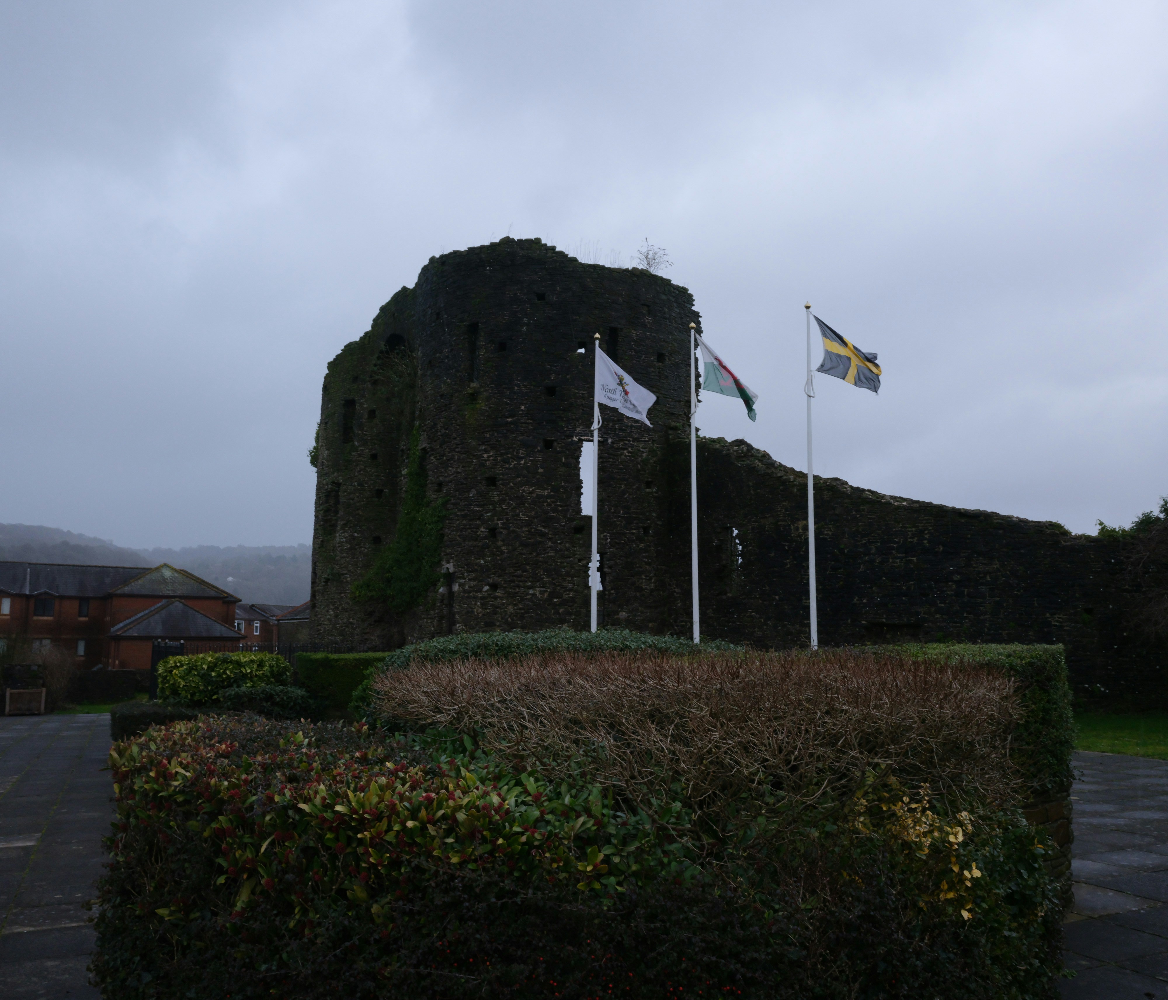 Flag-lit Ruins Overlook: Weathered Walls and Flag Parade