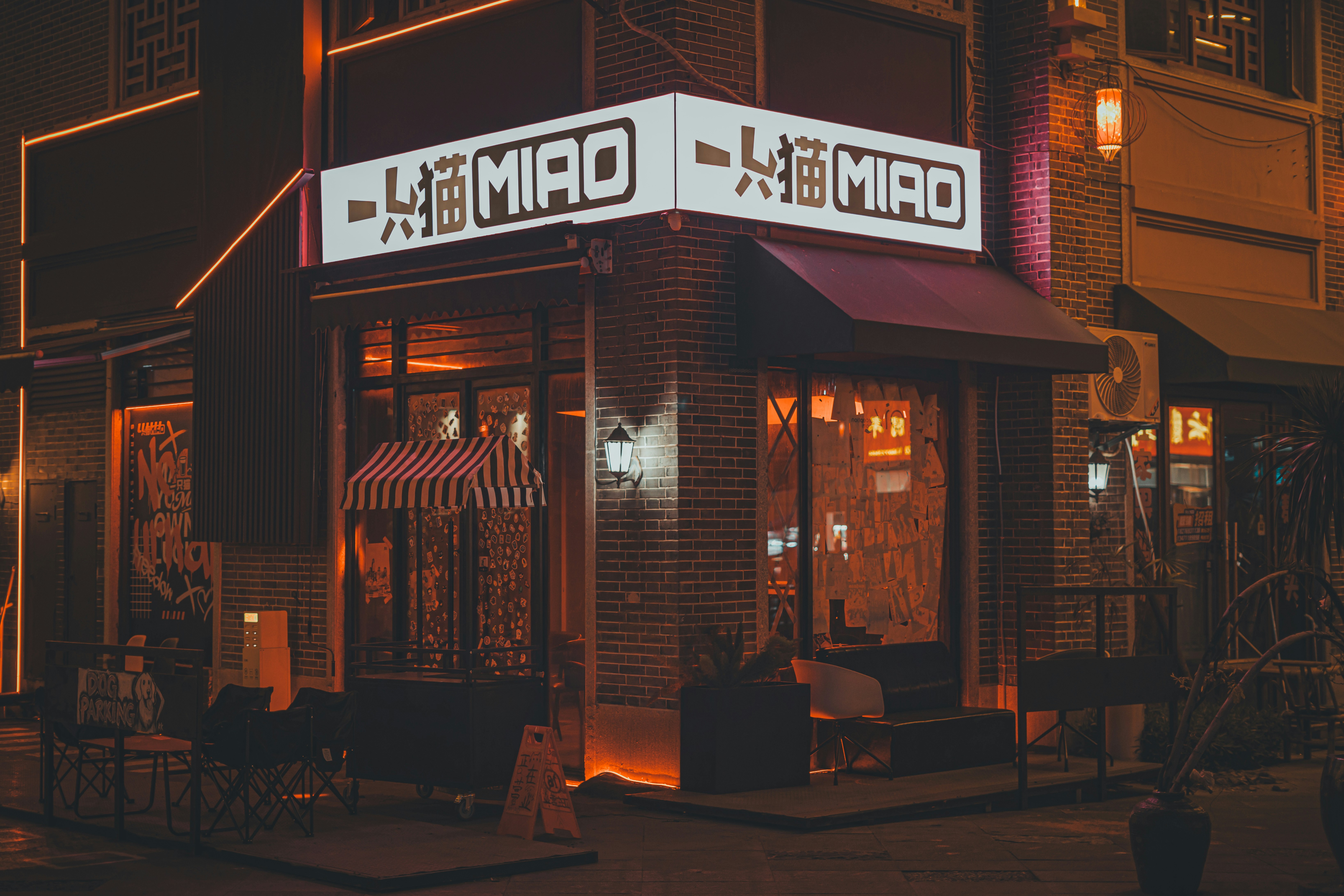 Corner building with illuminated sign at night