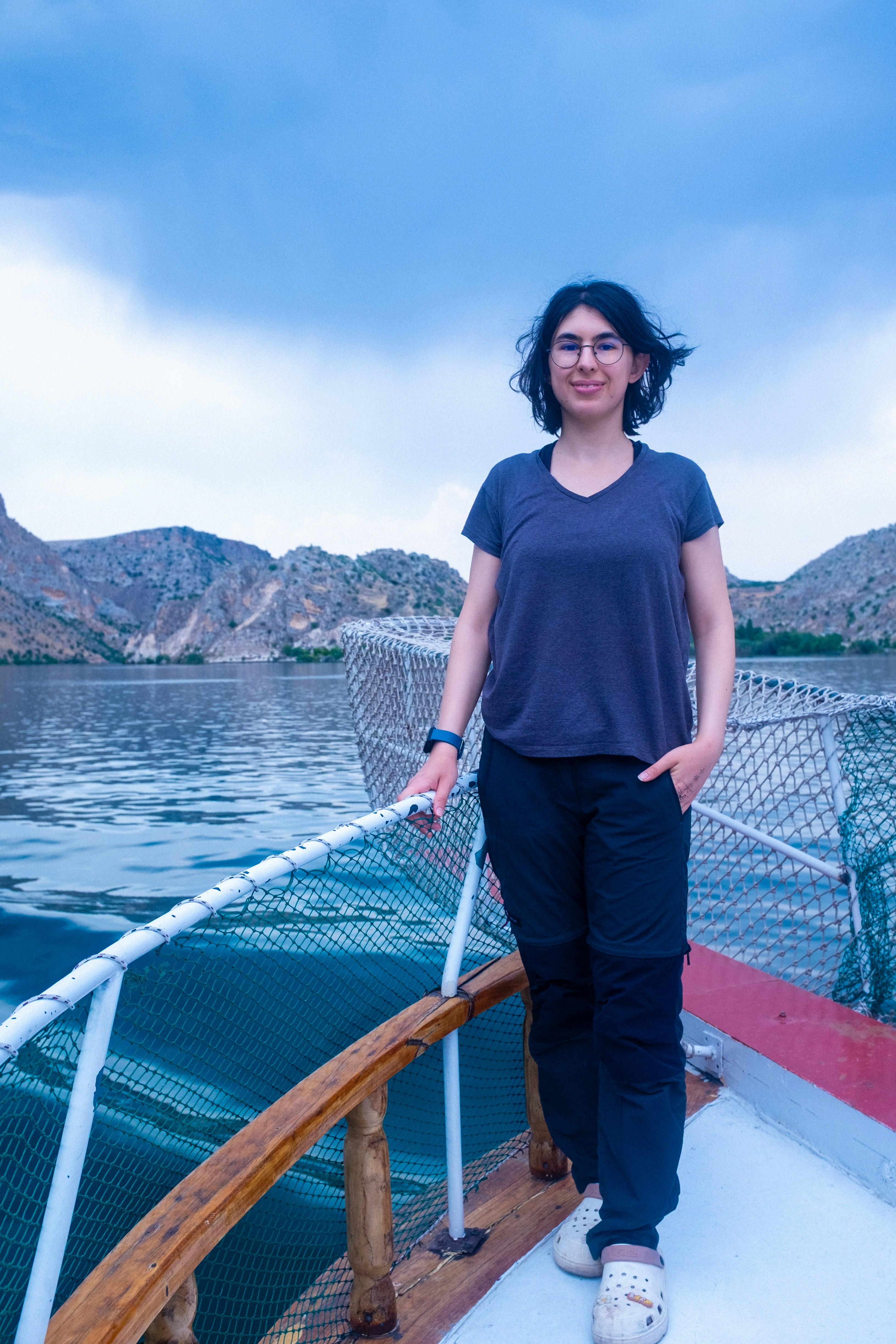 On the Bow: A Quiet Stance Against a Lake and Mountains