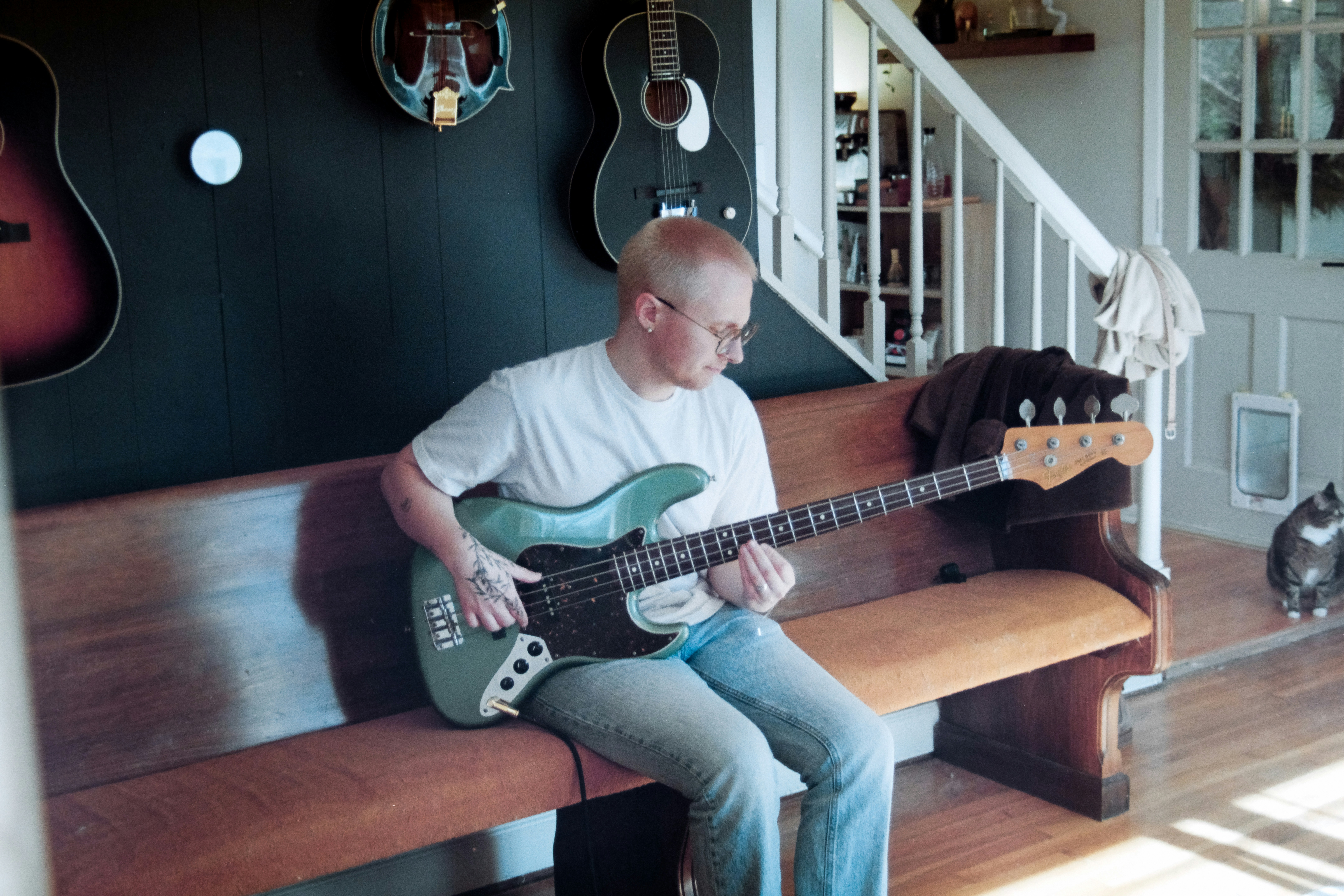 Electric Moment: Player with mint guitar on a wooden bench