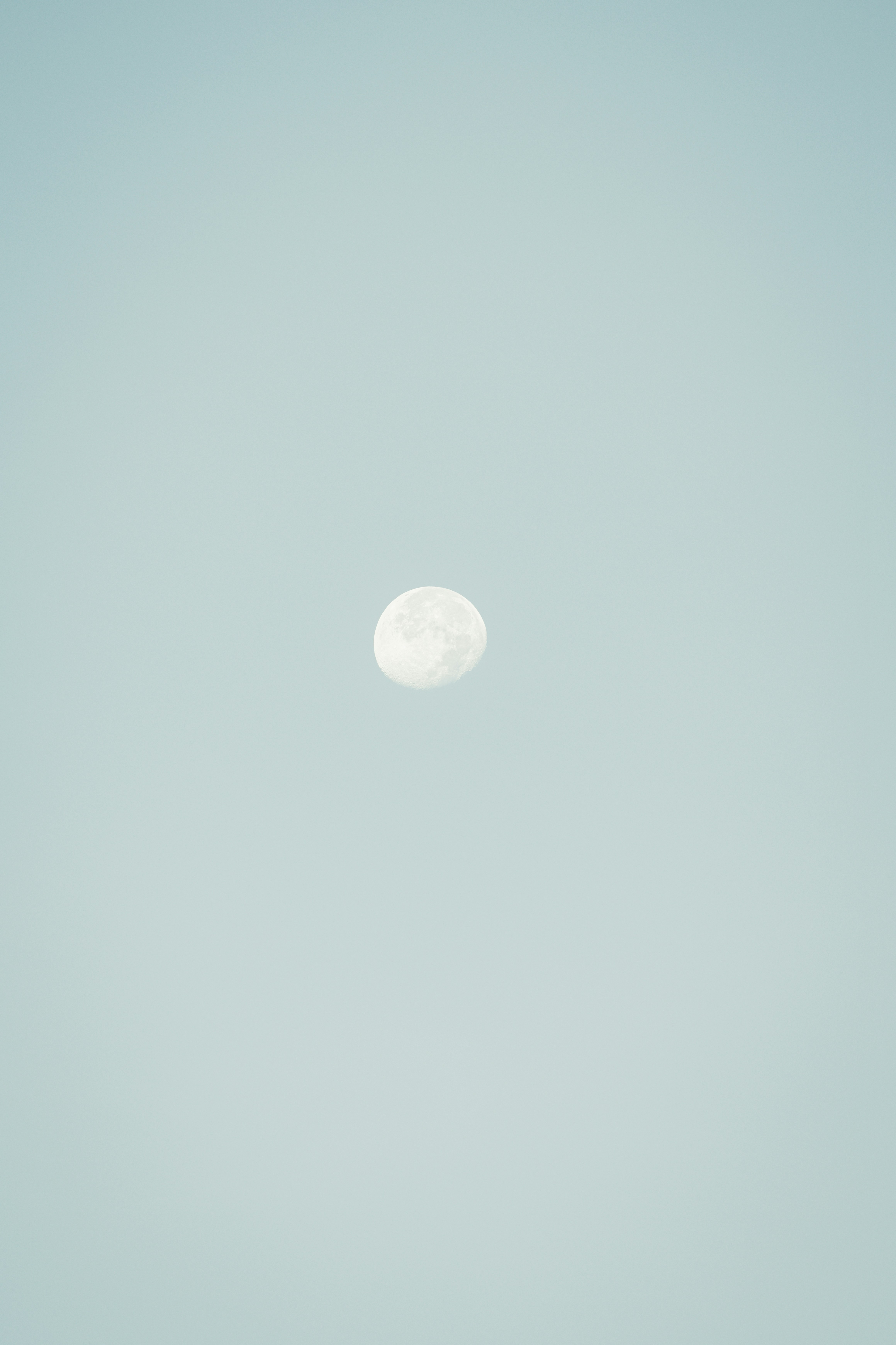 Moon in a Pale Sky: Subtle Gradient and Quiet Focus