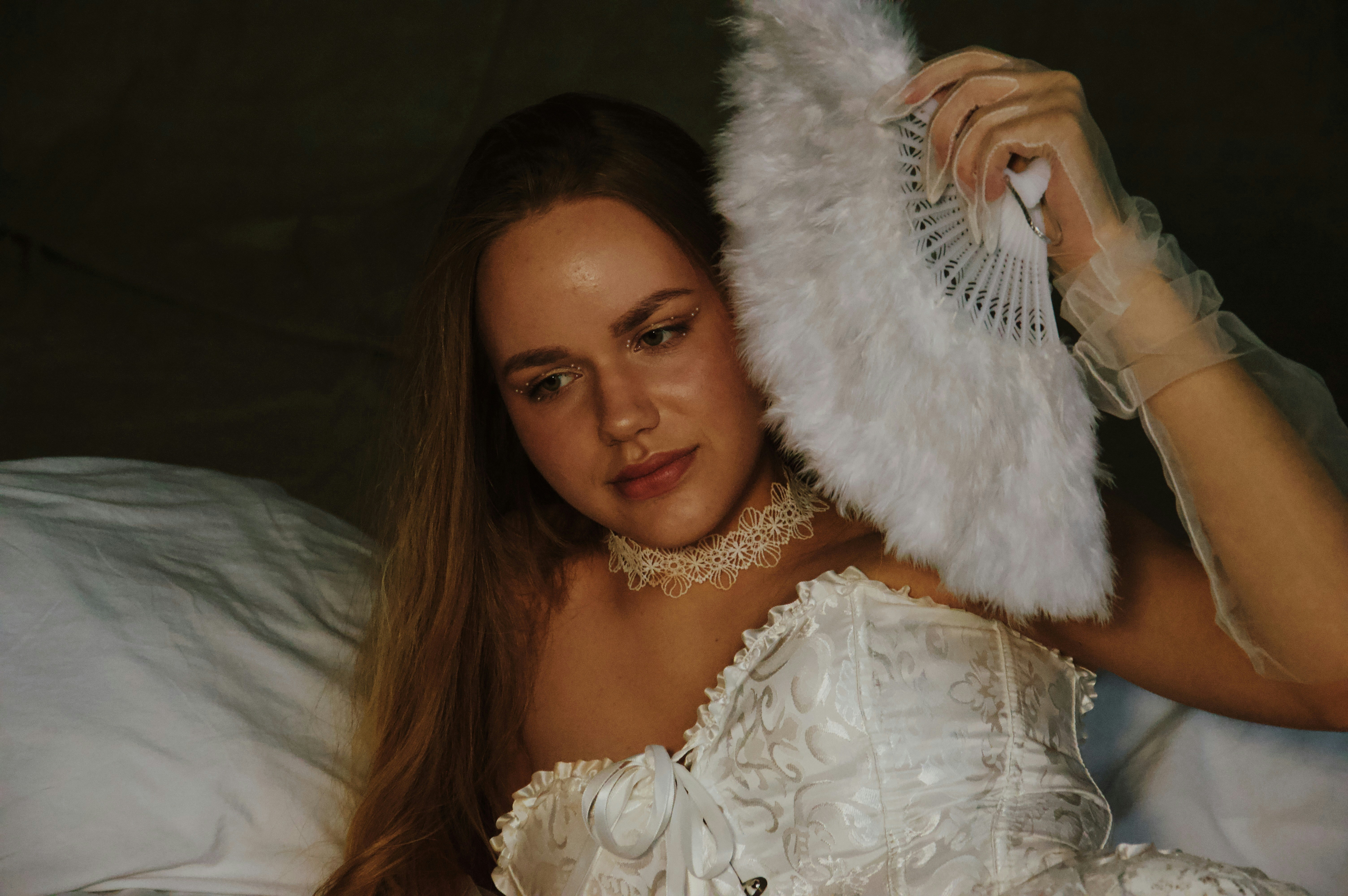 Luxurious Quiet: Bride with Fan in Soft Evening Light