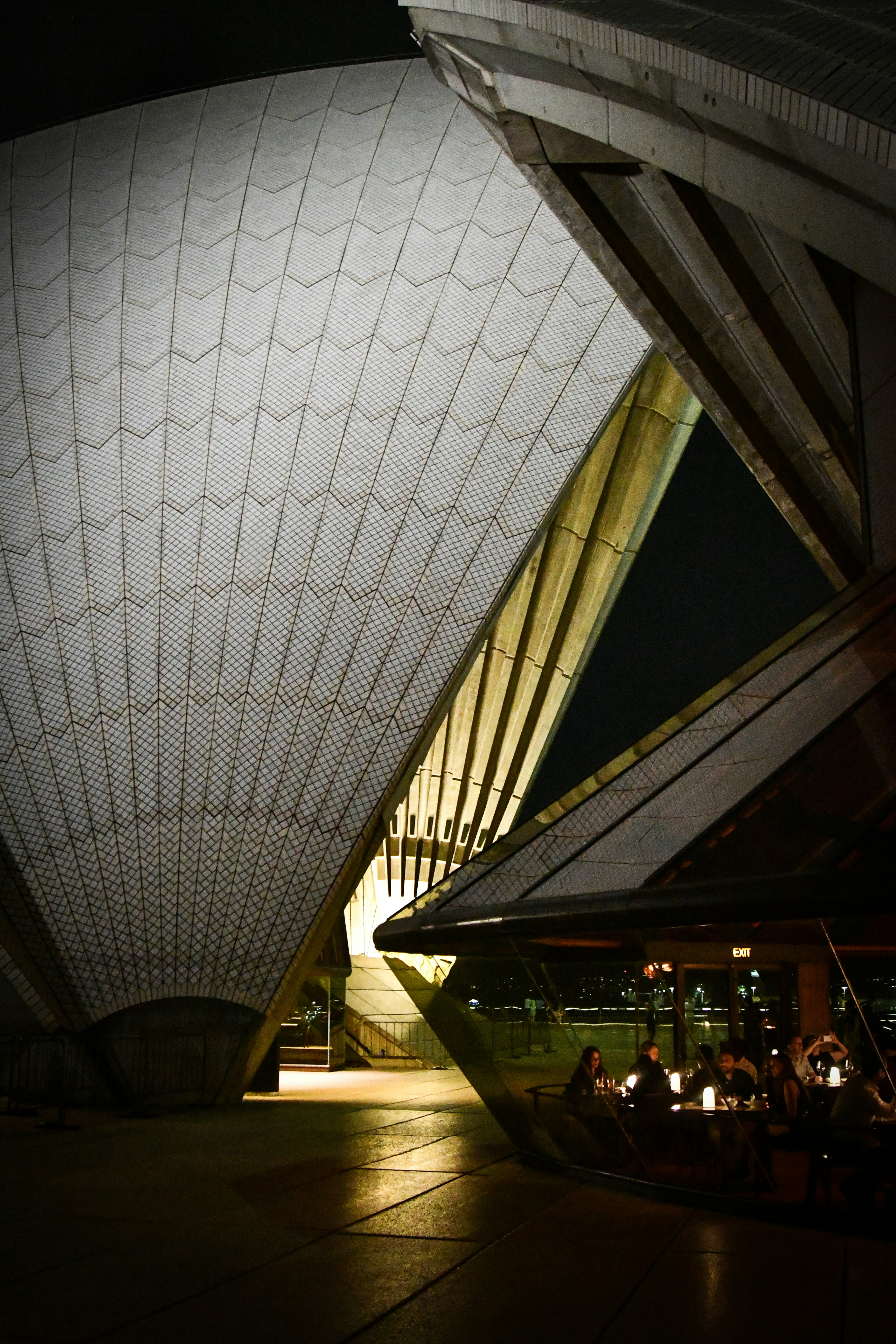 Architectural Night: Angled Facades Converging toward a Glass Terrace