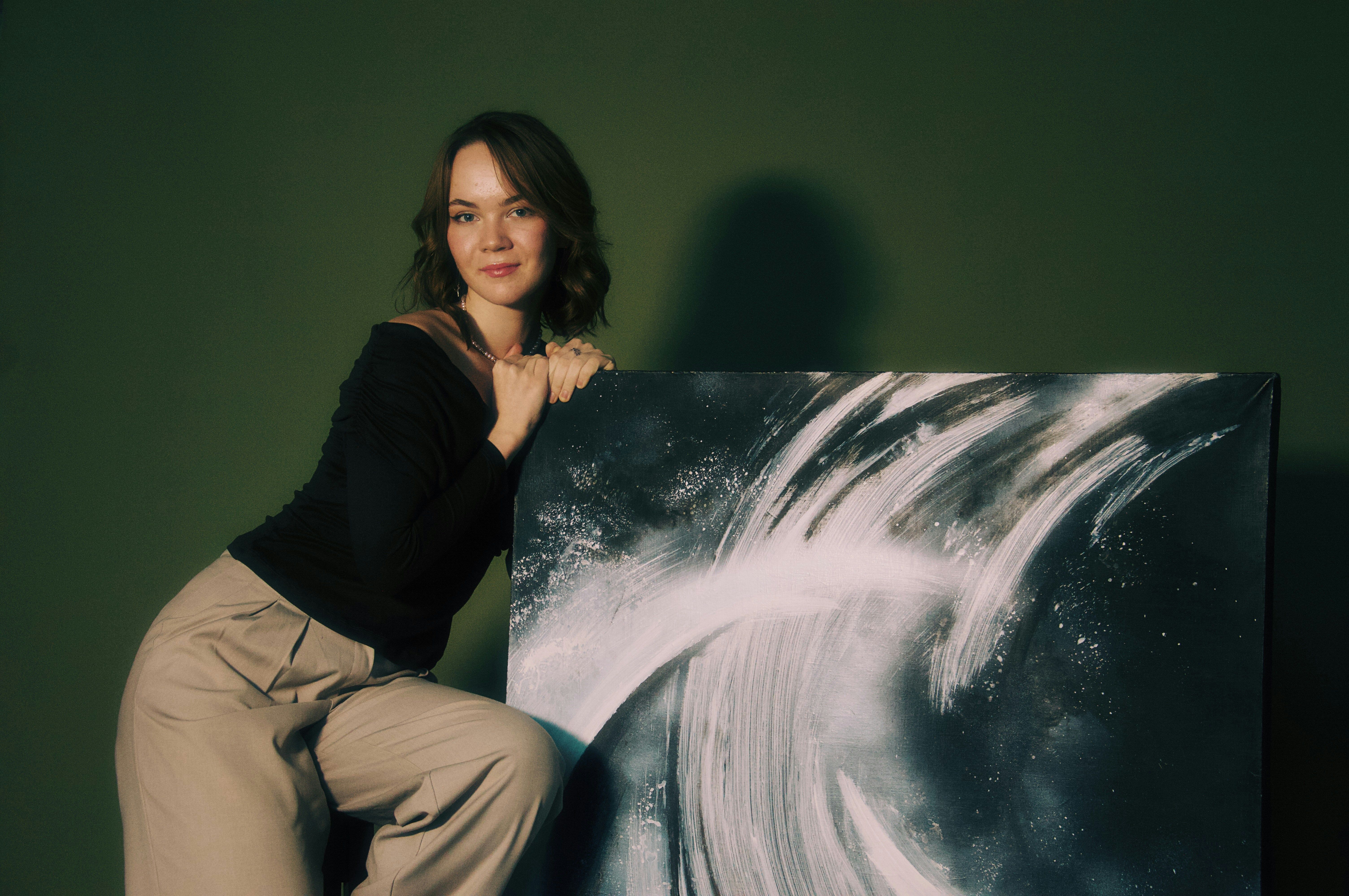Portrait with Creative Studio Canvas: A Woman and the Swirling Artwork