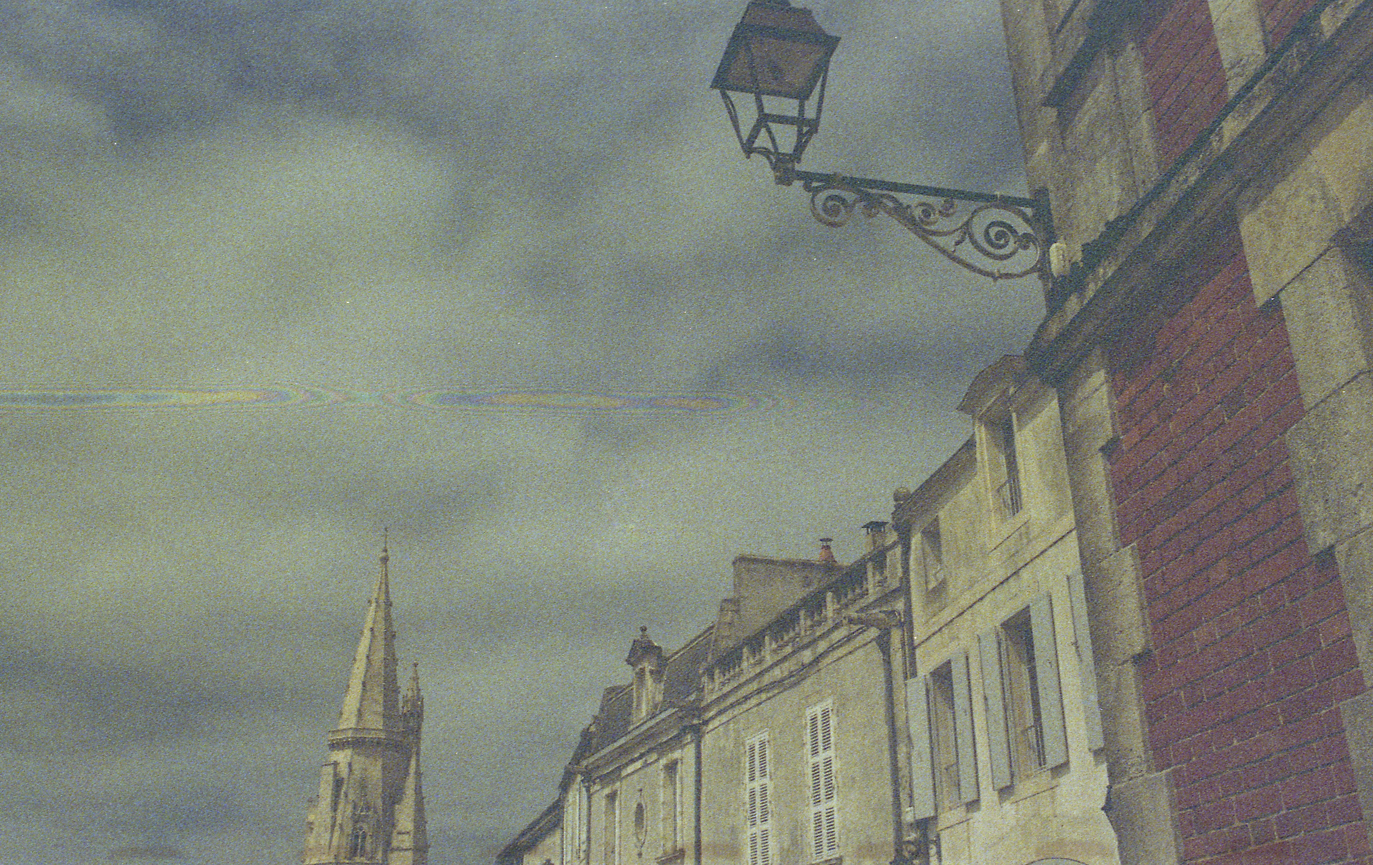 Ornate street lamp on a building facade