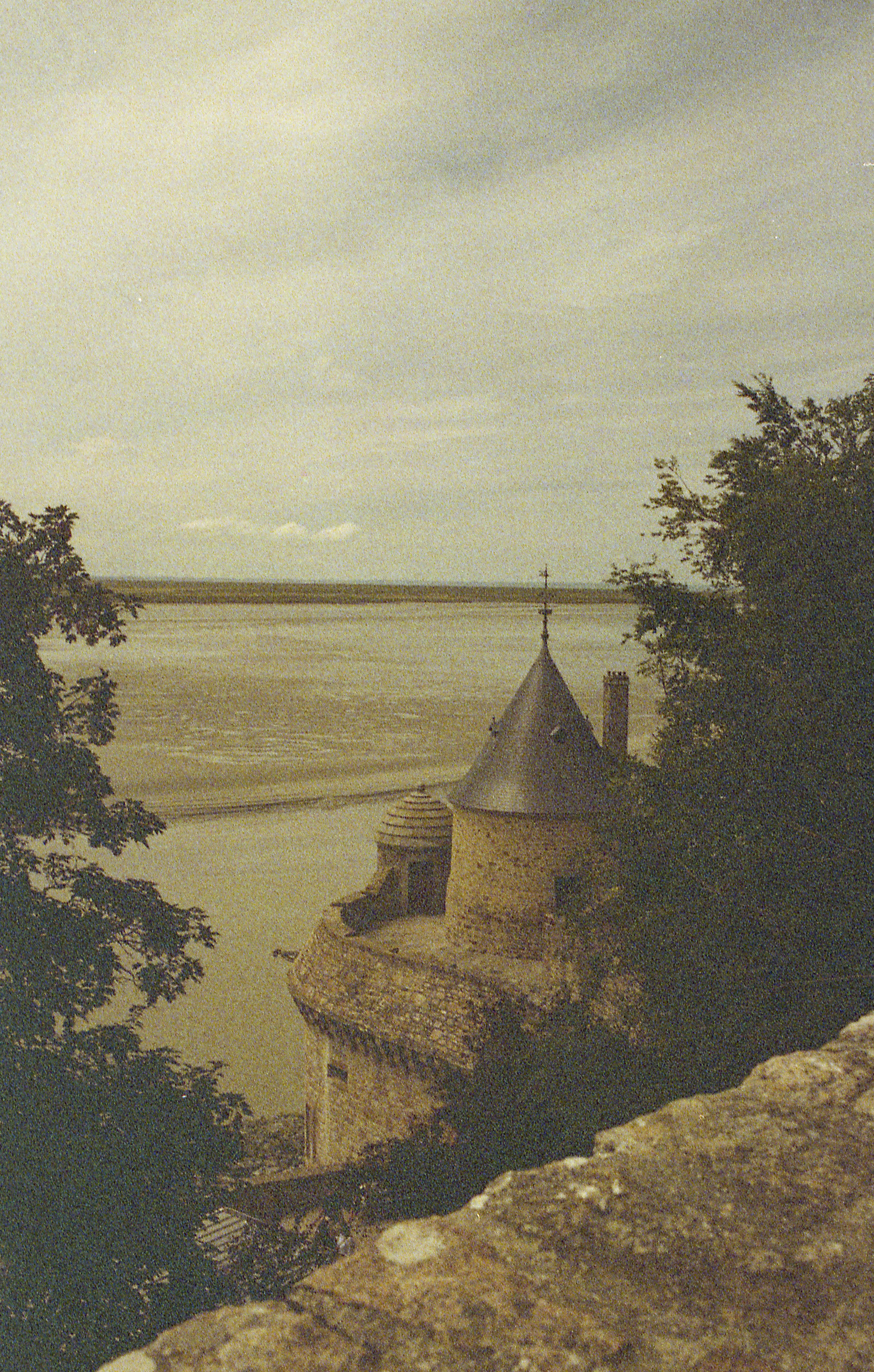 Stone tower overlooking a calm body of water