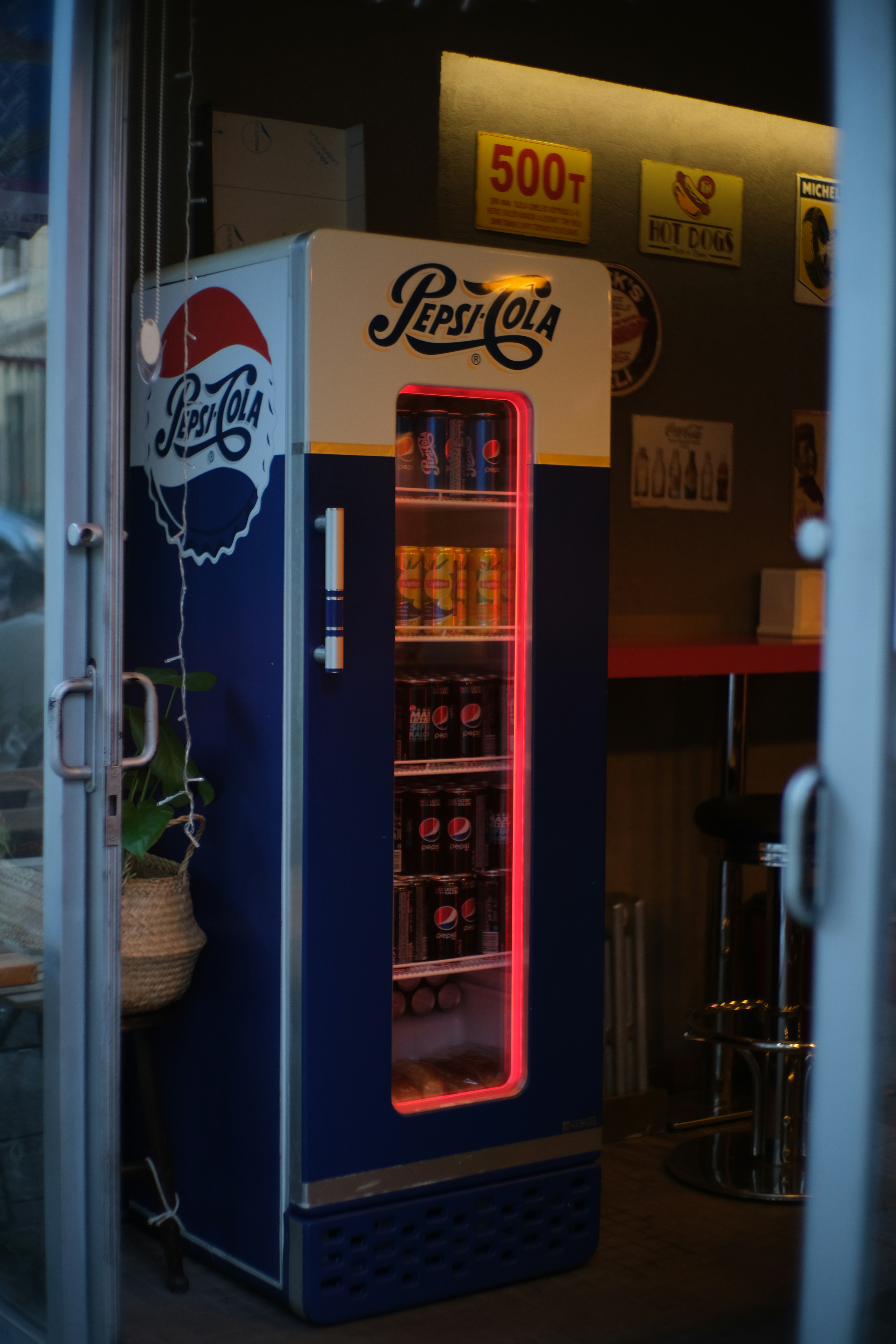 Vivid Pepsi-Cola Fridge Standing Guard in a Dim Corner