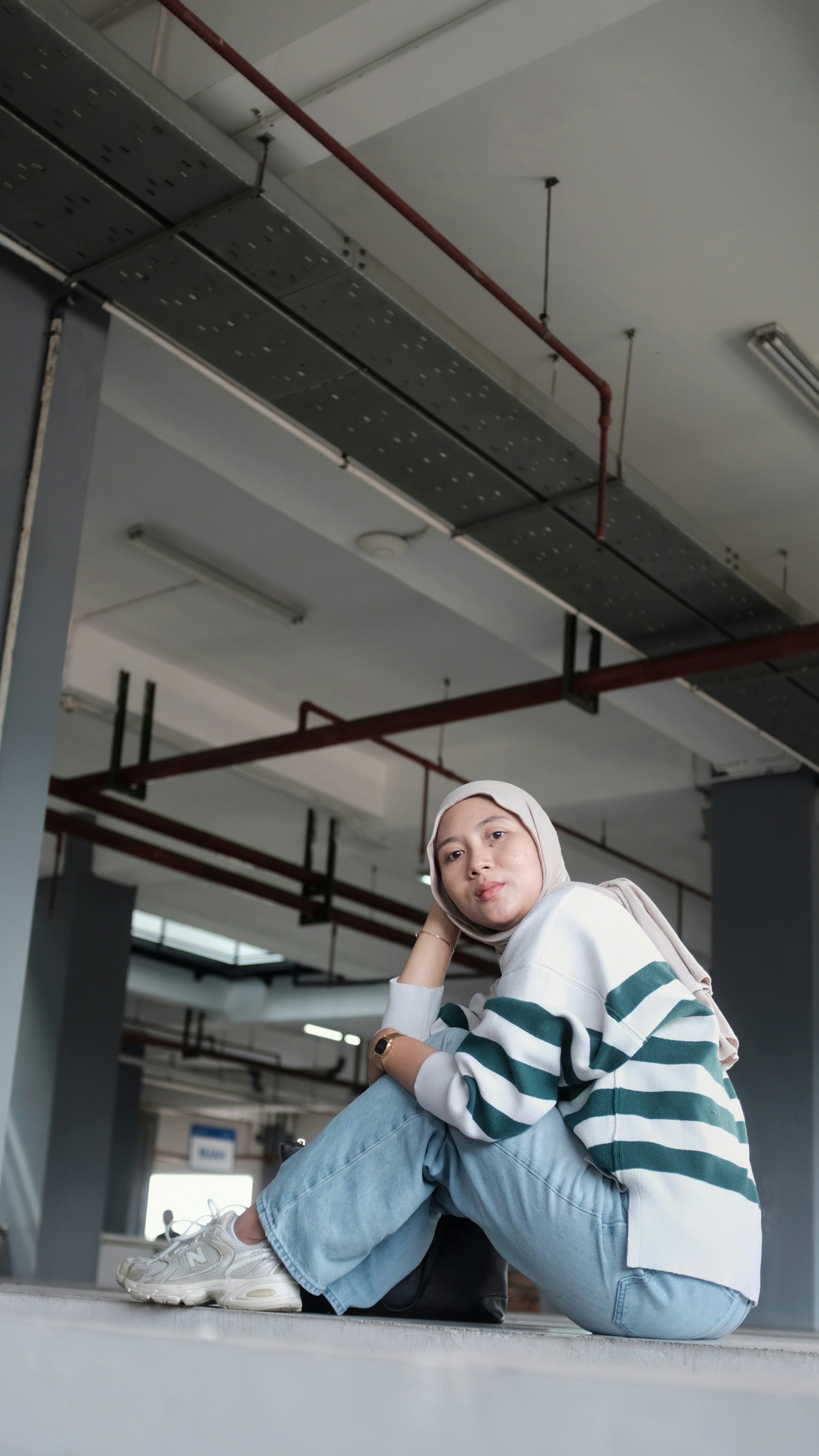 Underground Quiet: A Casual Moment Beneath Industrial Beams