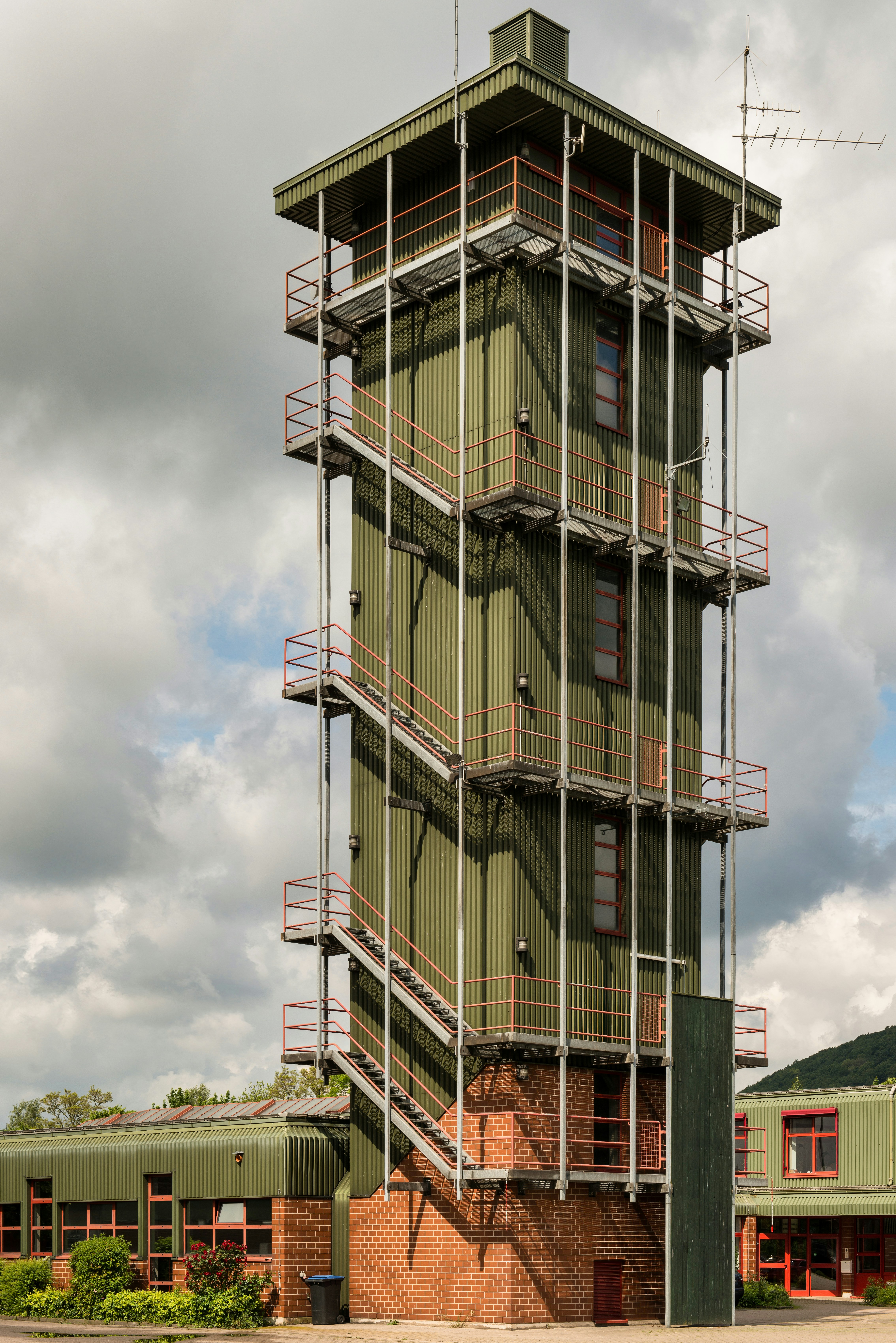 Watchtower Overlook: A Weathered Green Sentinel Rising Above Brick Foundations