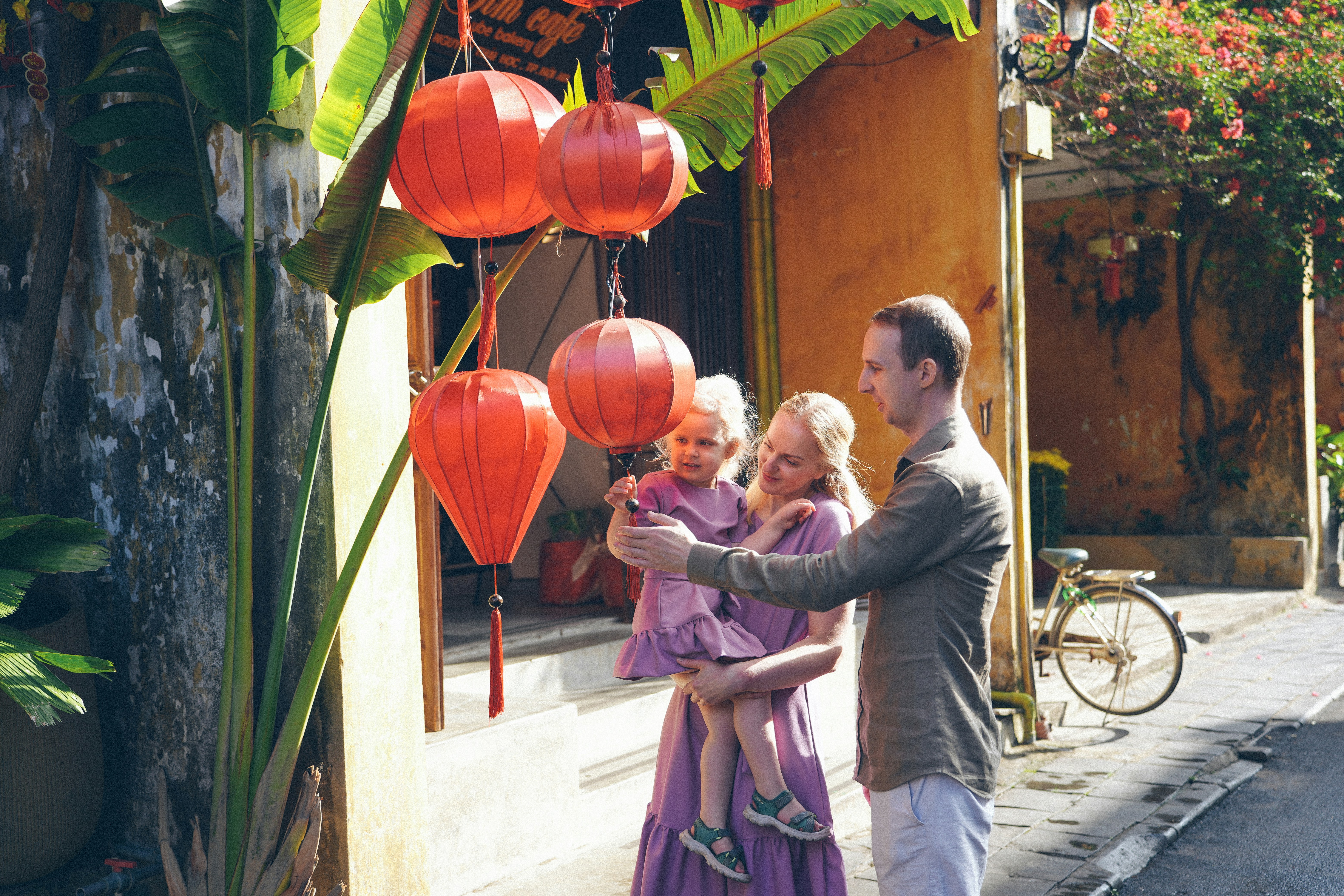 Family Adorns Lanterns: A Moment of Shared Joy by the Street