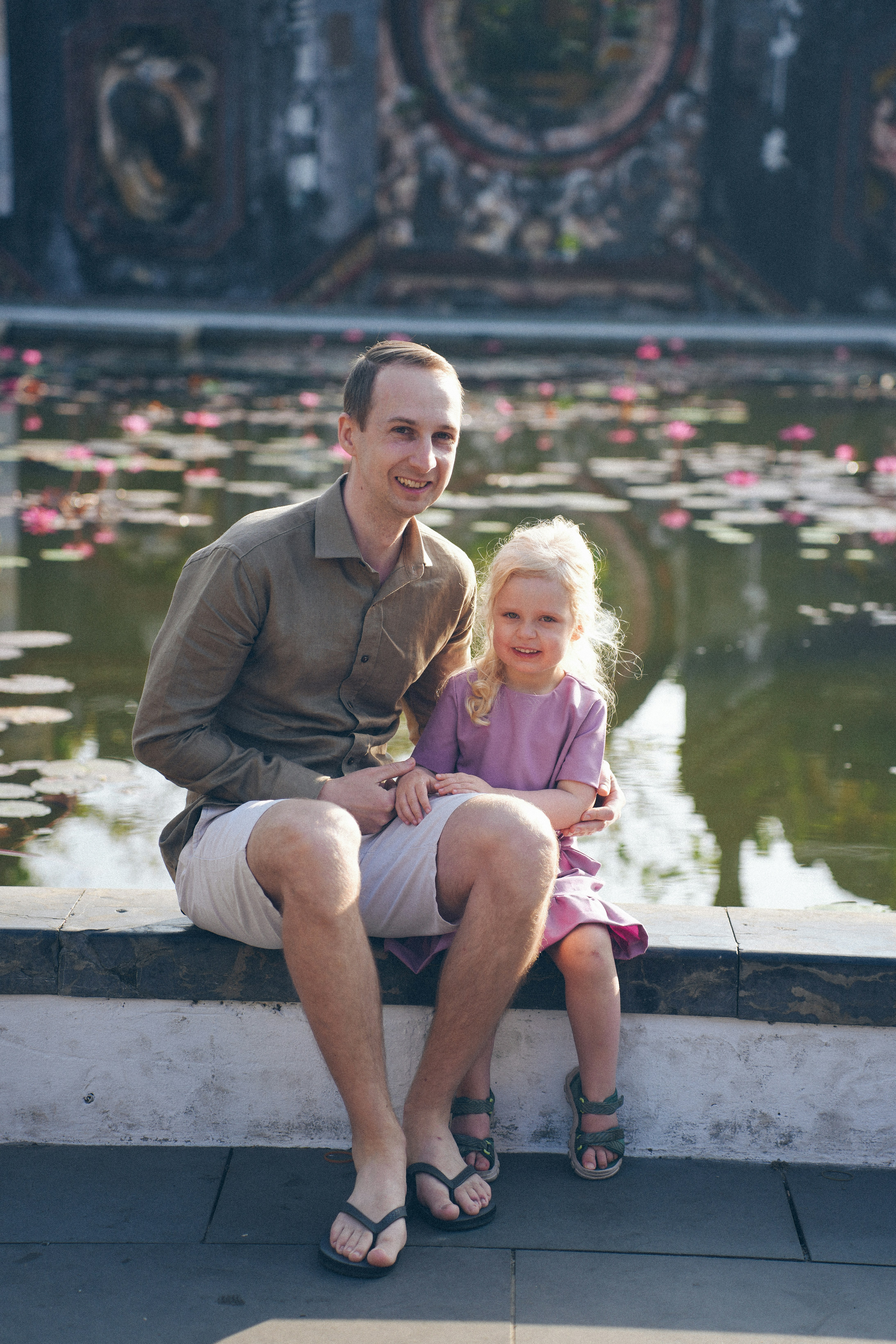 Duo by the Fountain: A Quiet Moment by Lily Pond