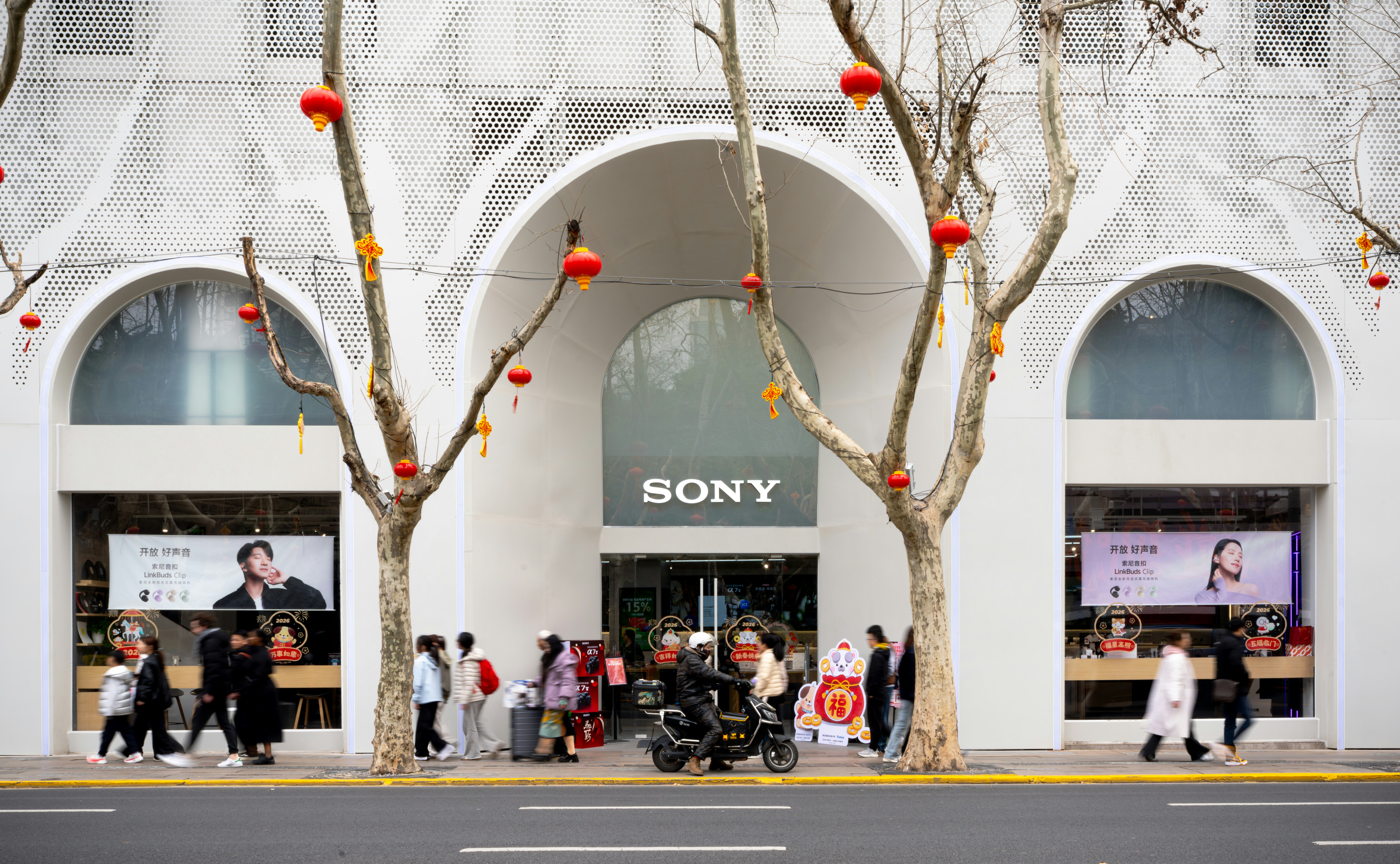 Sony Store Front: Neon Logo Amid Minimalist Arches and Street Life