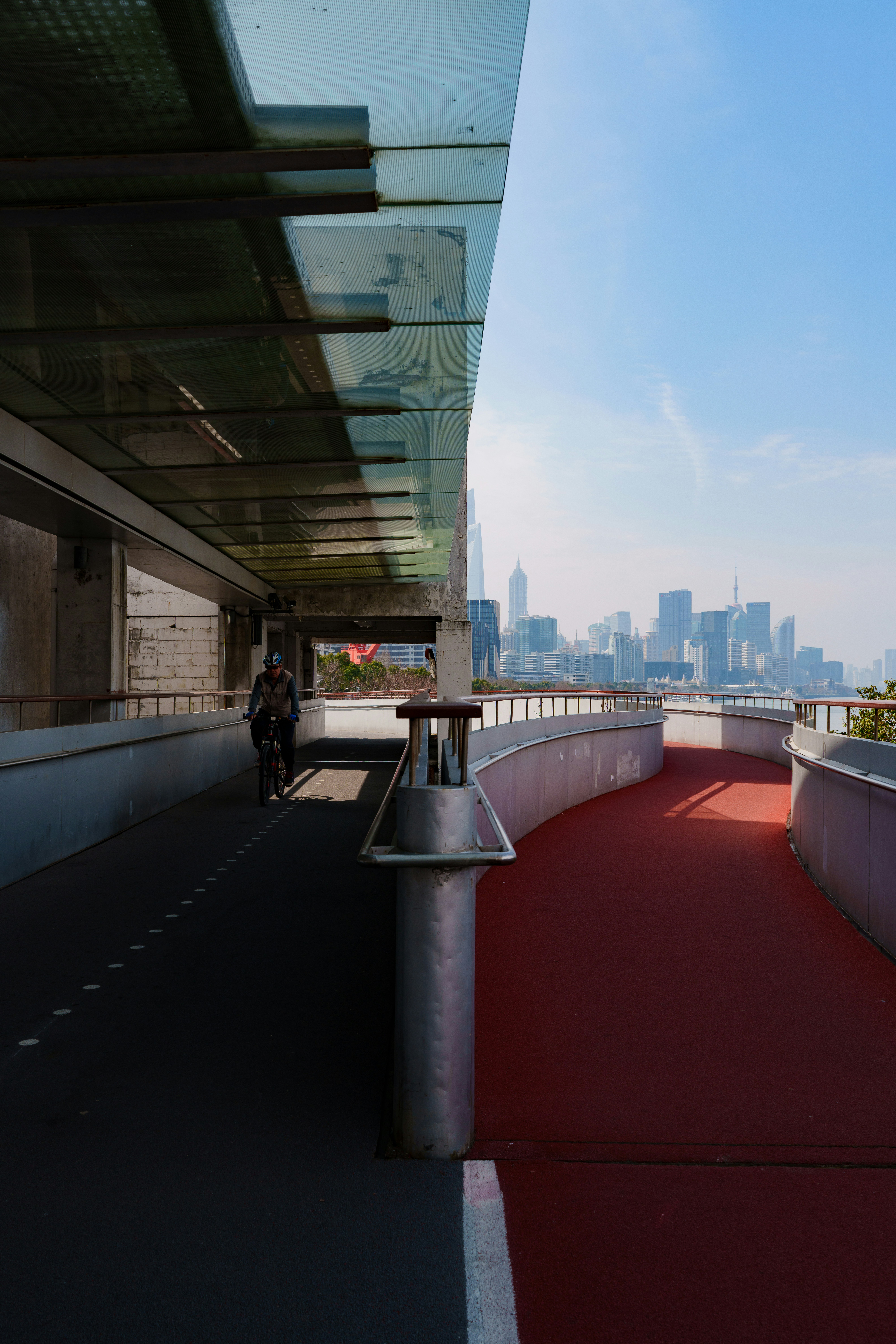 Red River Loop: Cyclist Bordered by Urban Horizon