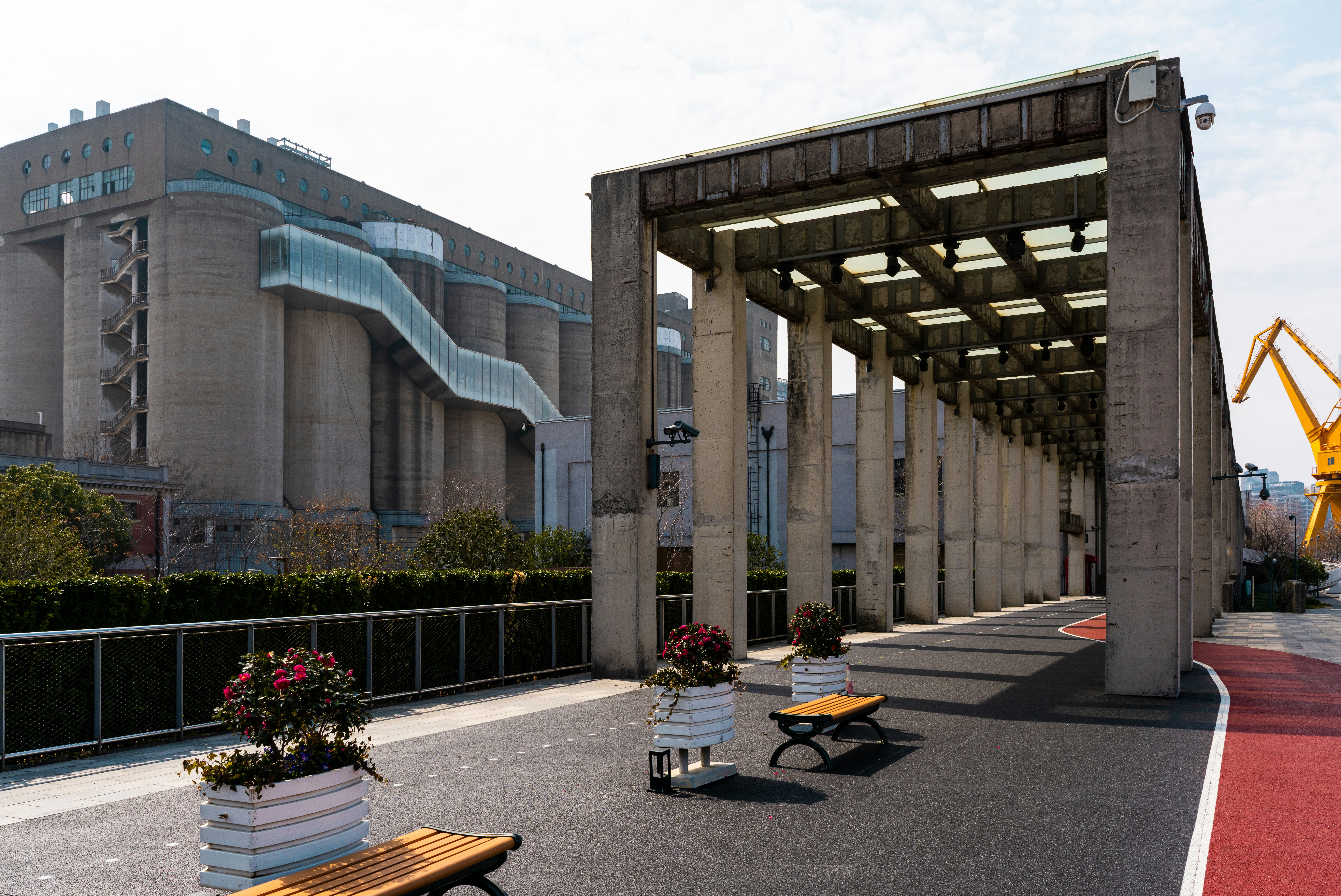 Concrete Corridor of Light: A Sunlit Industrial Walkway
