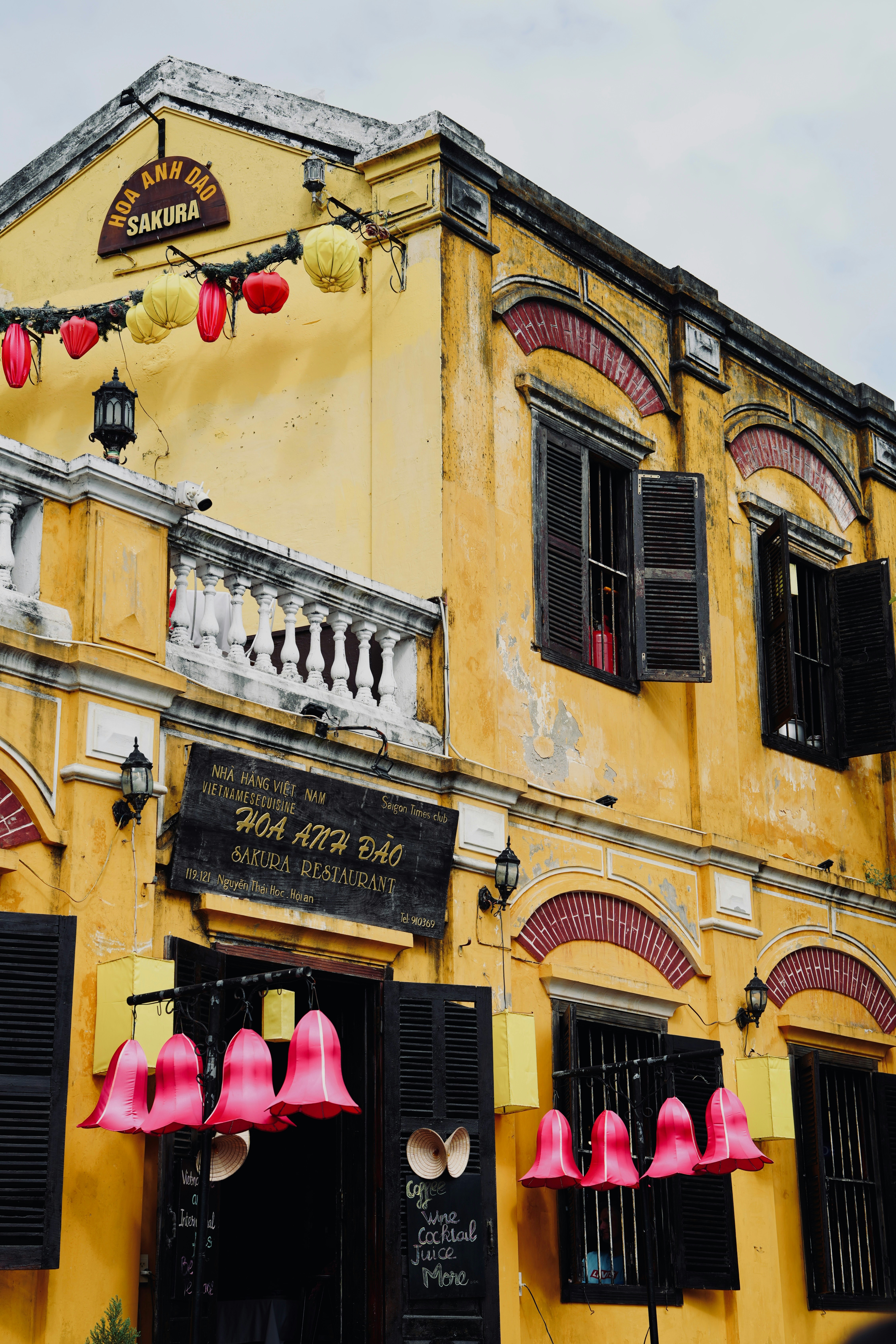 Yellow Facade of a Vietnamese-Style Restaurant with Pink Lanterns