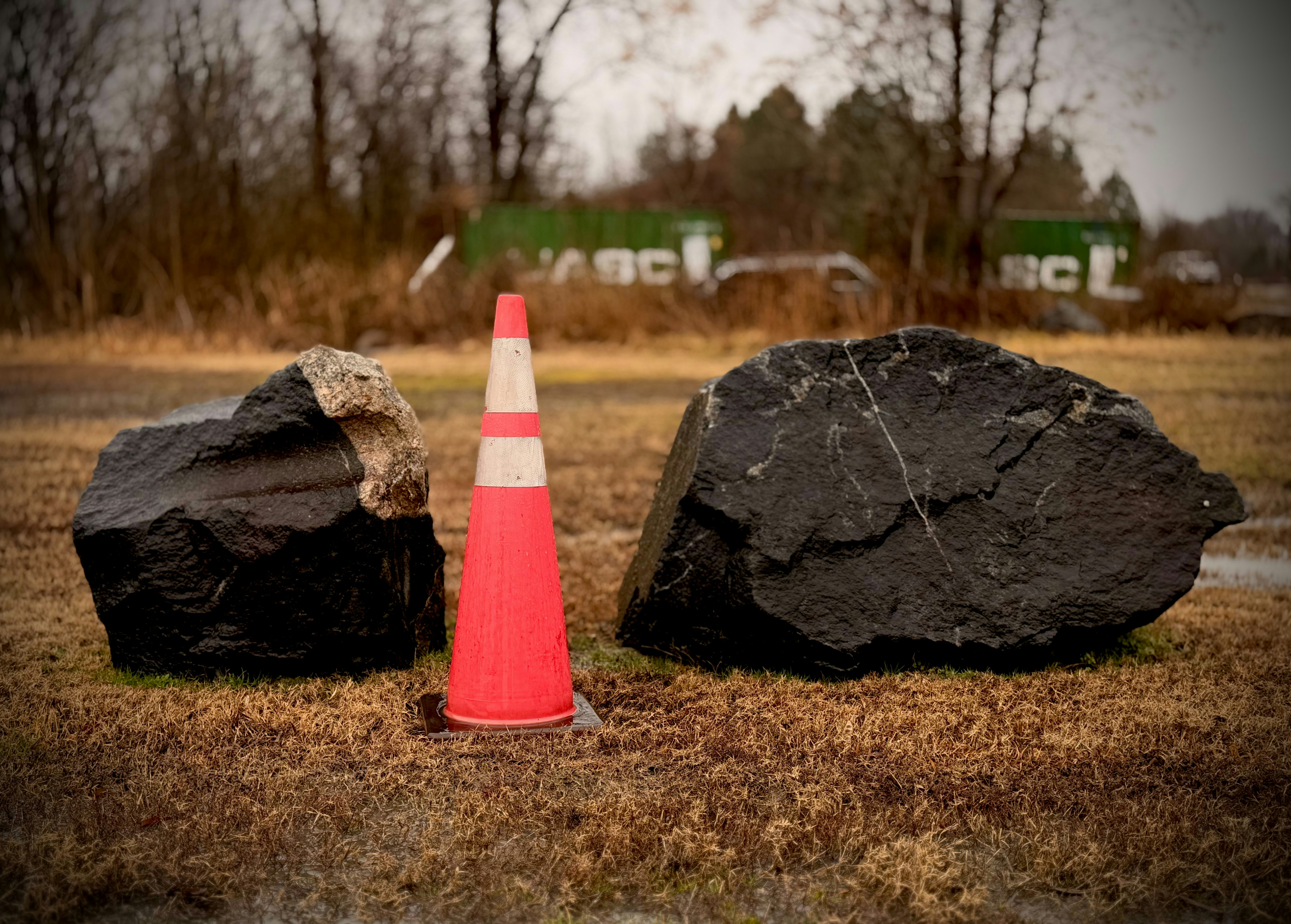 Orange Cone Between Monolithic Rocks: A Quiet Field Study in Texture and Scale
