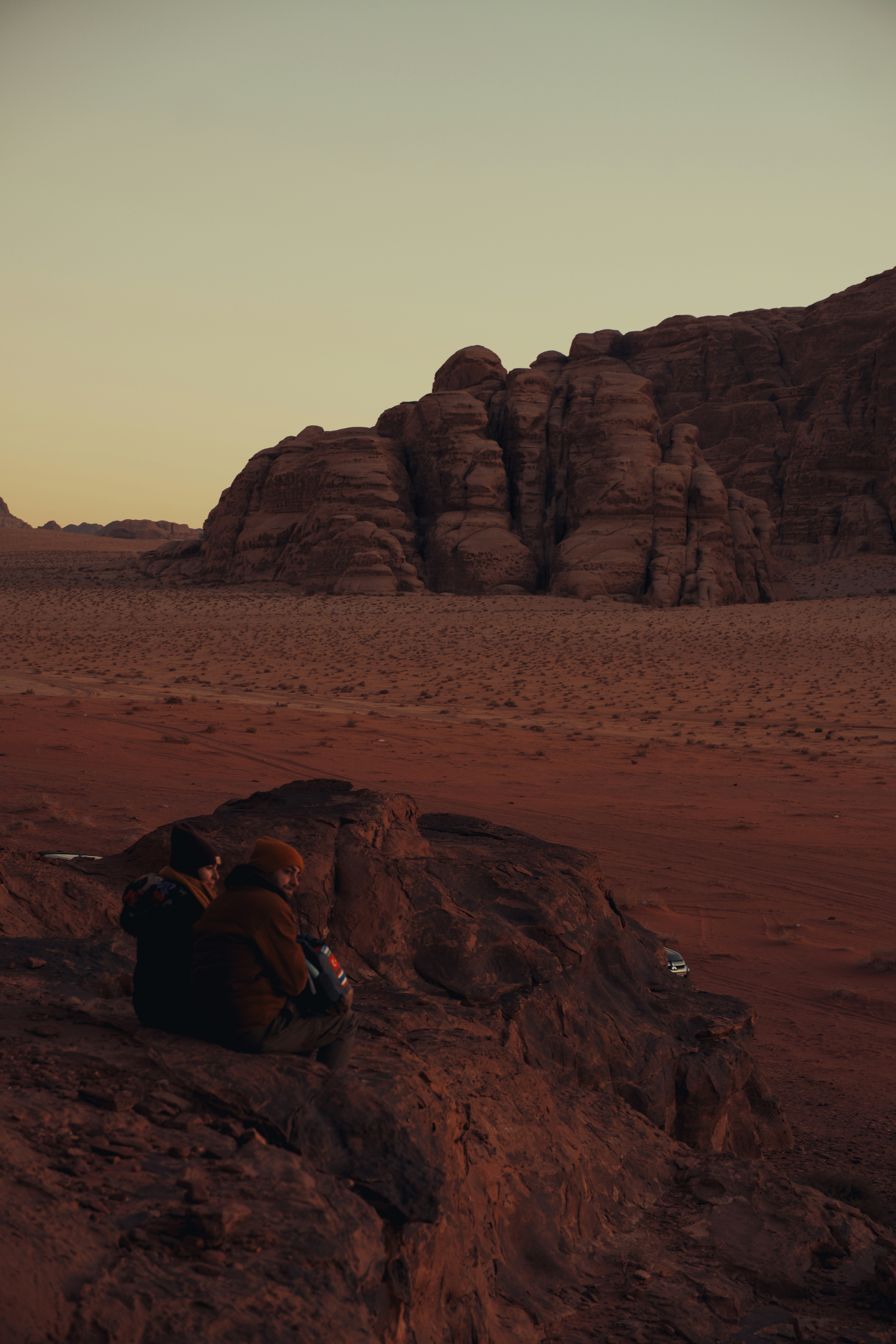 Desert Promontory: Climbers at Dusk on Worn Stone