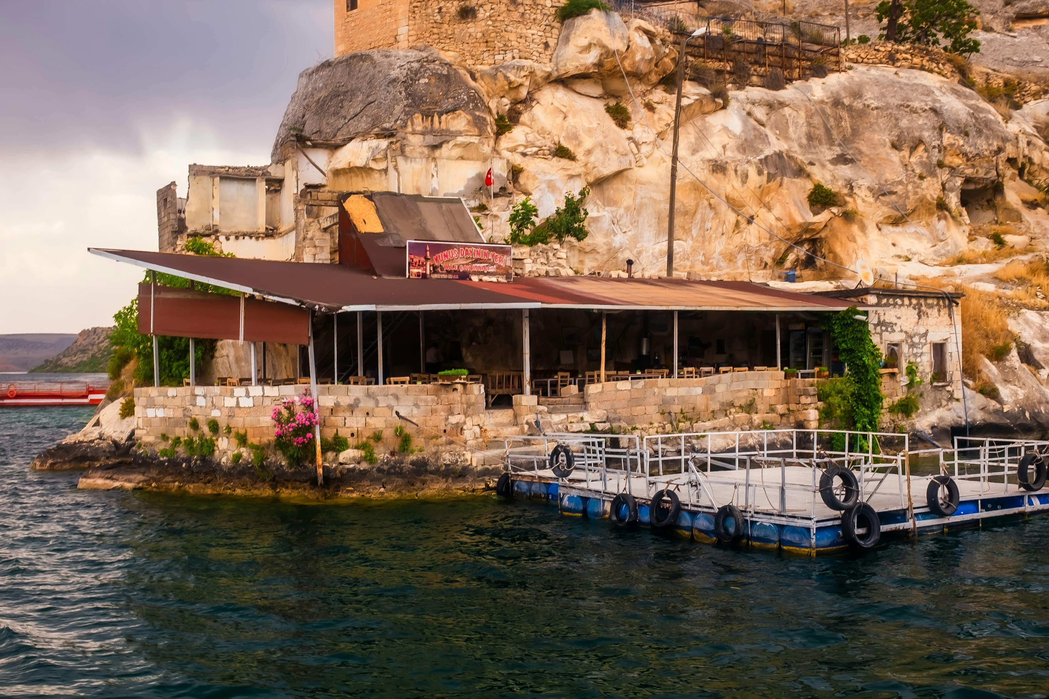 Harborside Bistro Nestled Against Weathered Cliff