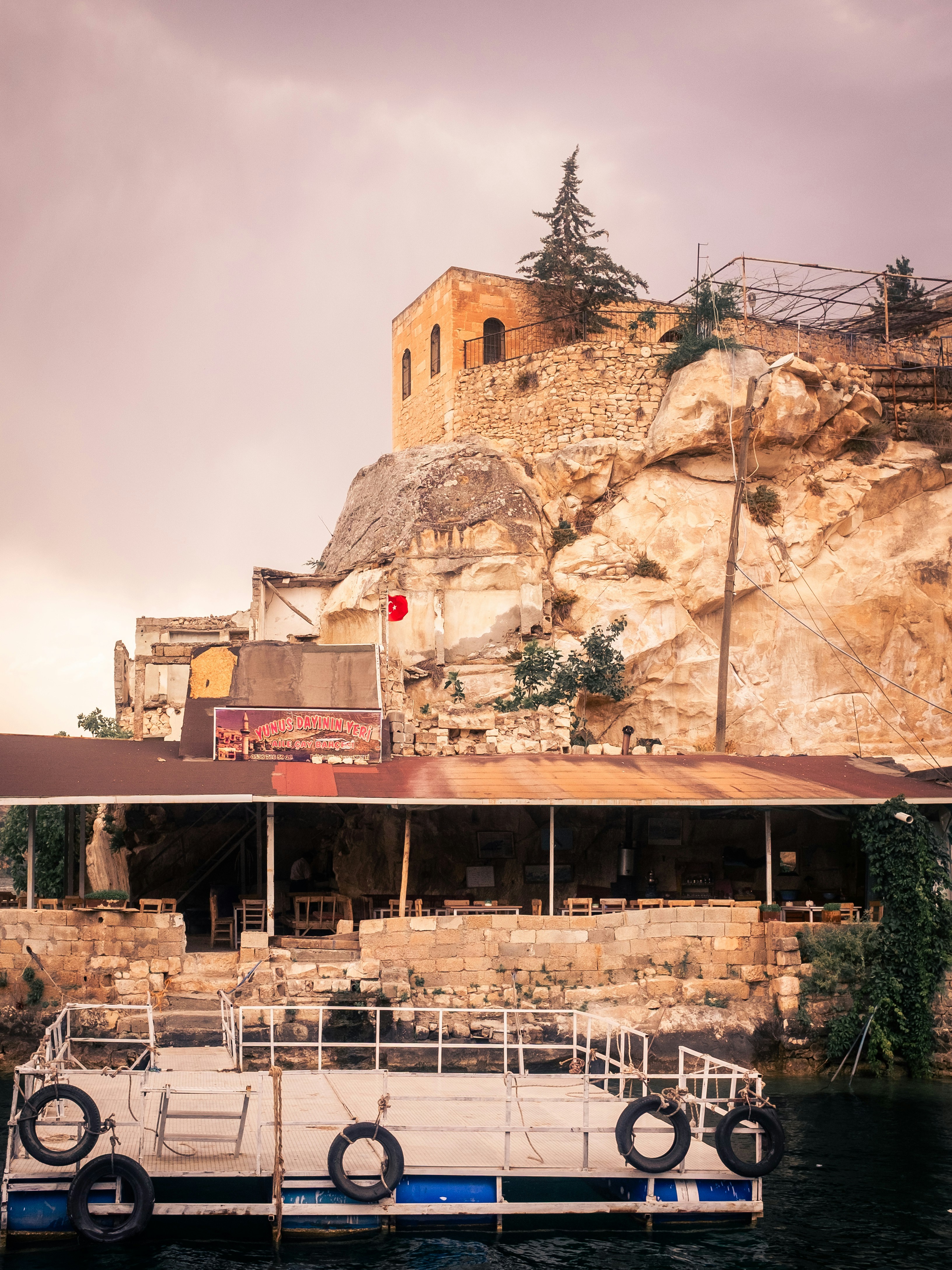 Ancient Cliffside Harbor: Stone Outpost Over Calm Waters
