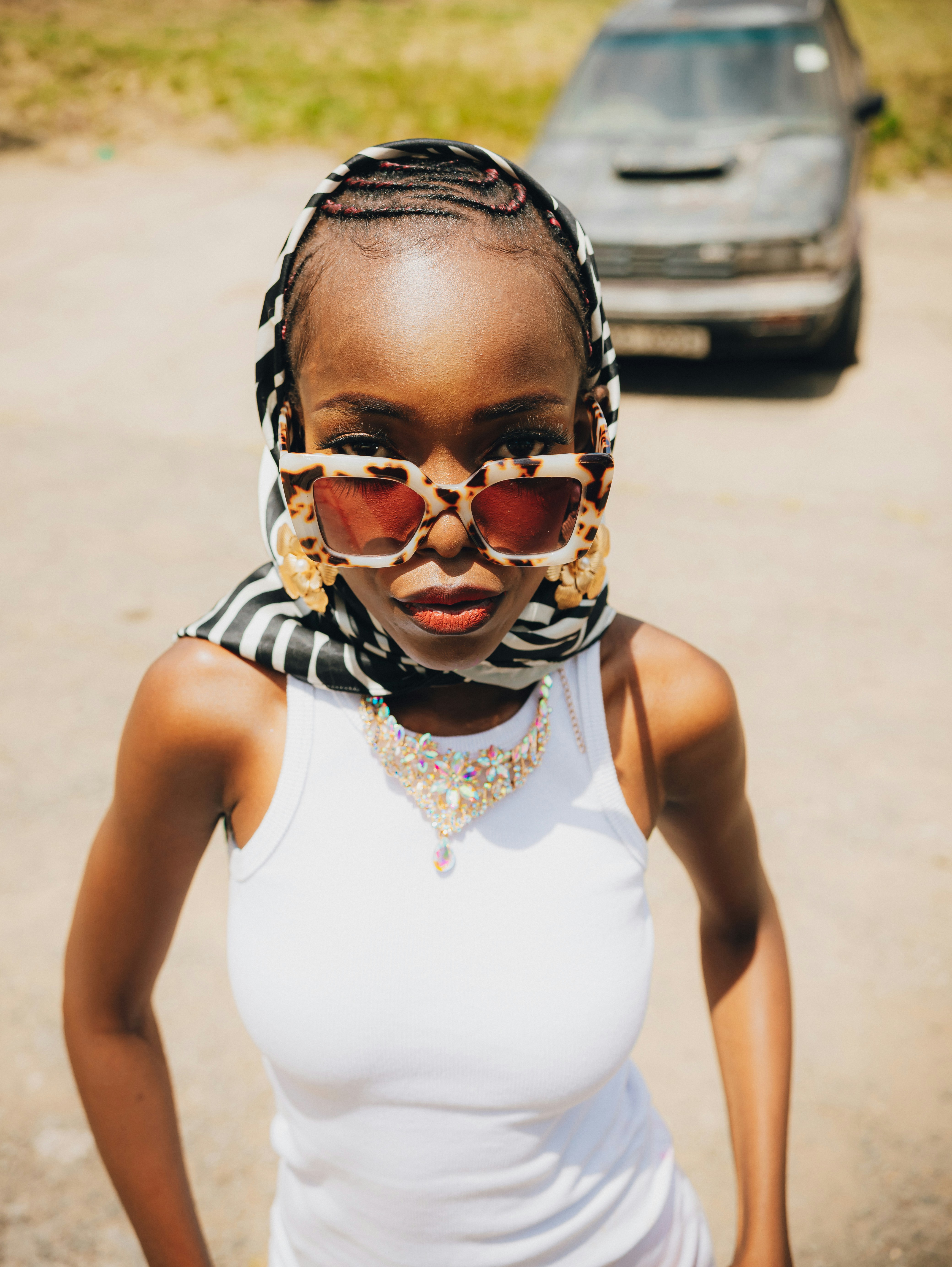 Bold Portrait Under Sun: A Teen in Leopard Sunglasses