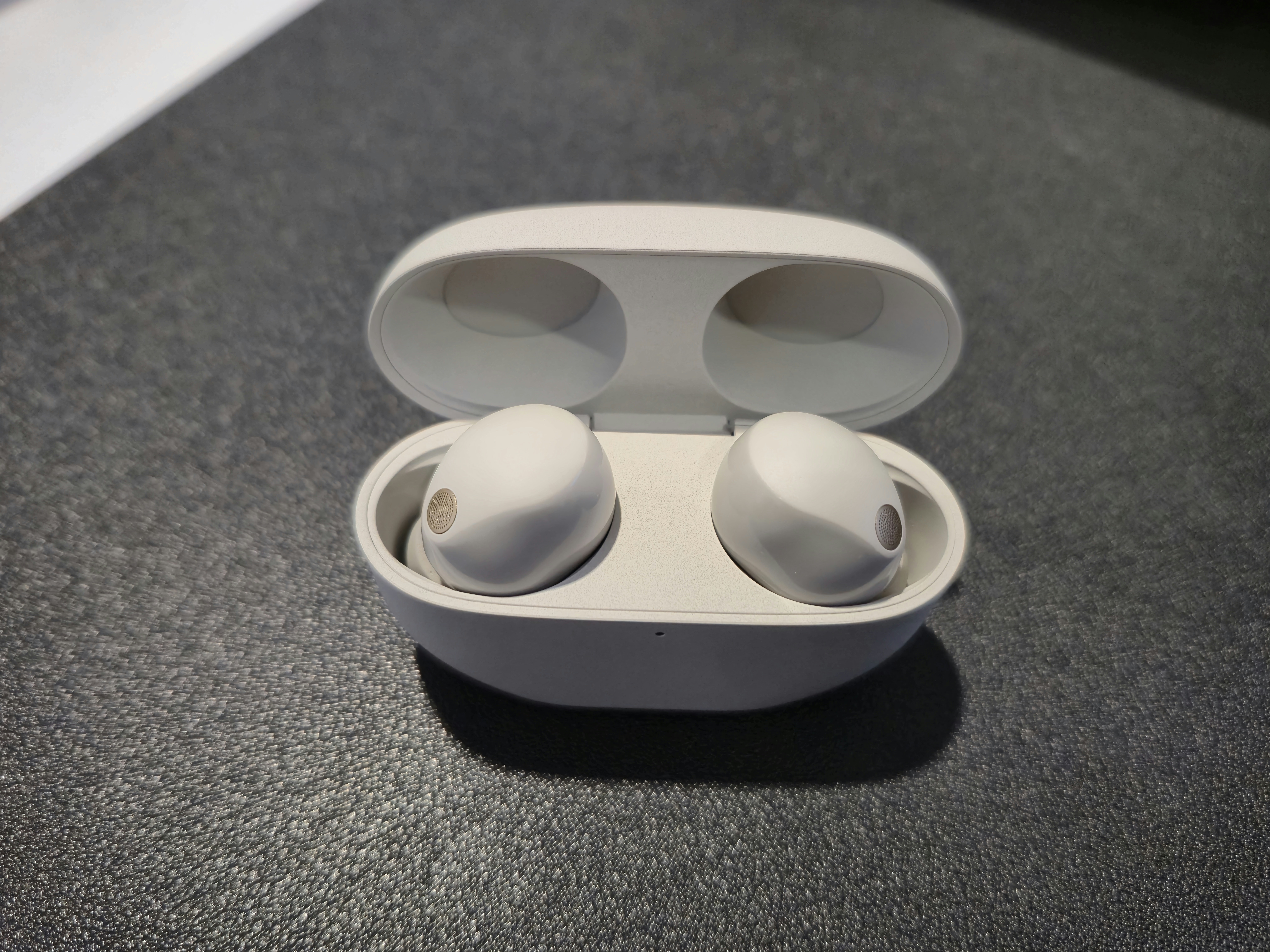 White wireless earbuds in charging case