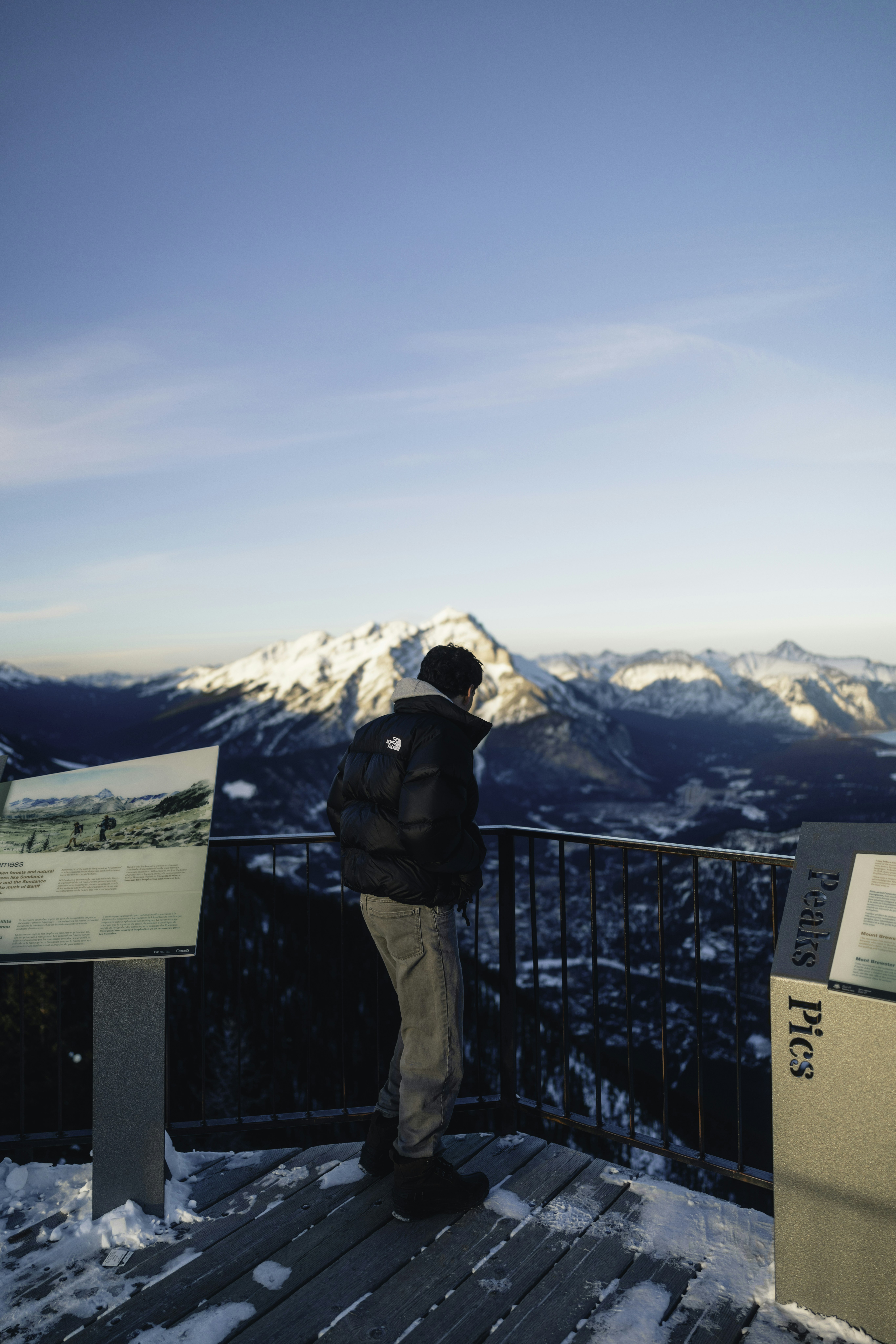 Traveler at the Snow-Blanketed Vista Overlooking Alpine Peaks