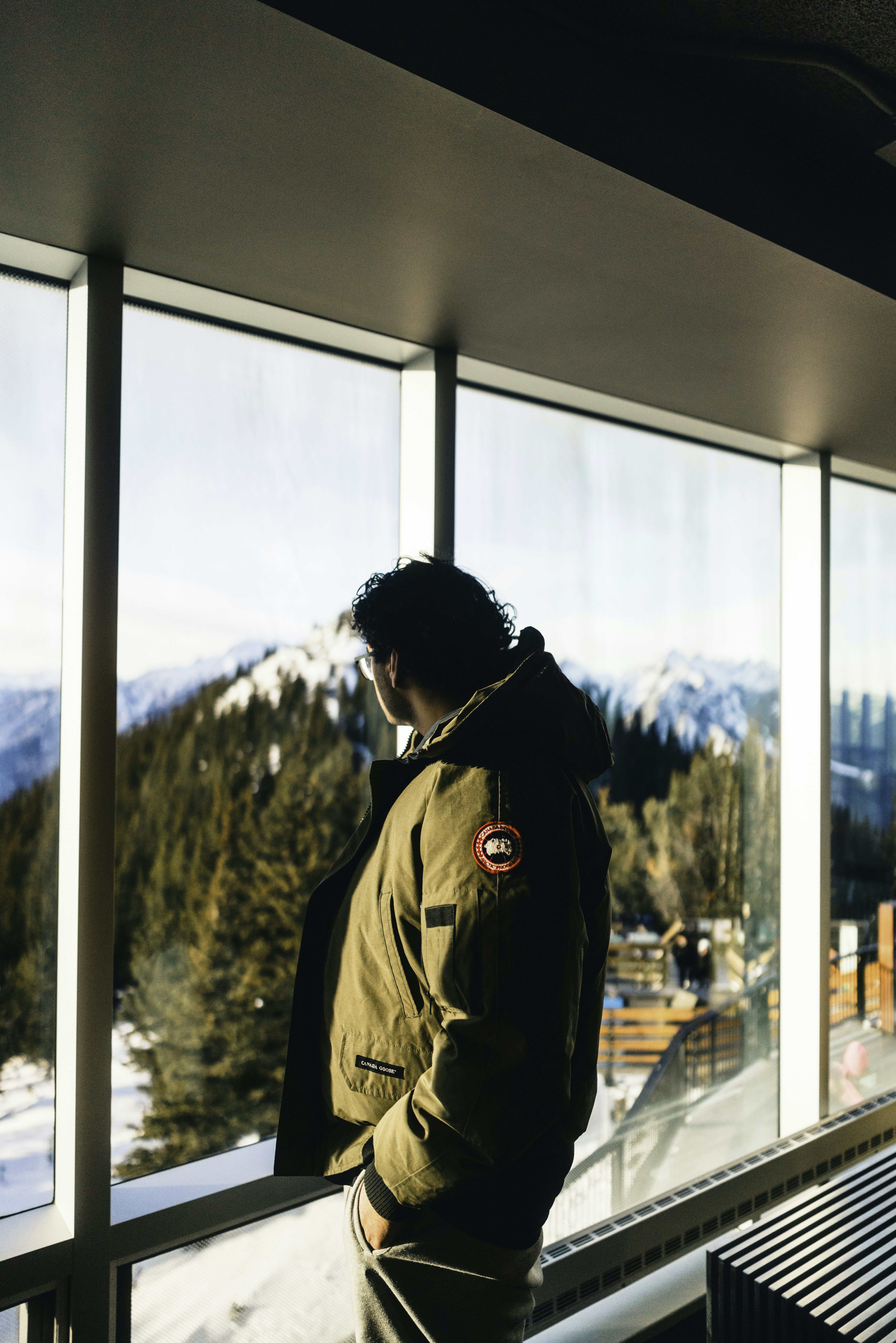 Windowed Vista: A Lonely Moment Between Mountain Light and Glass