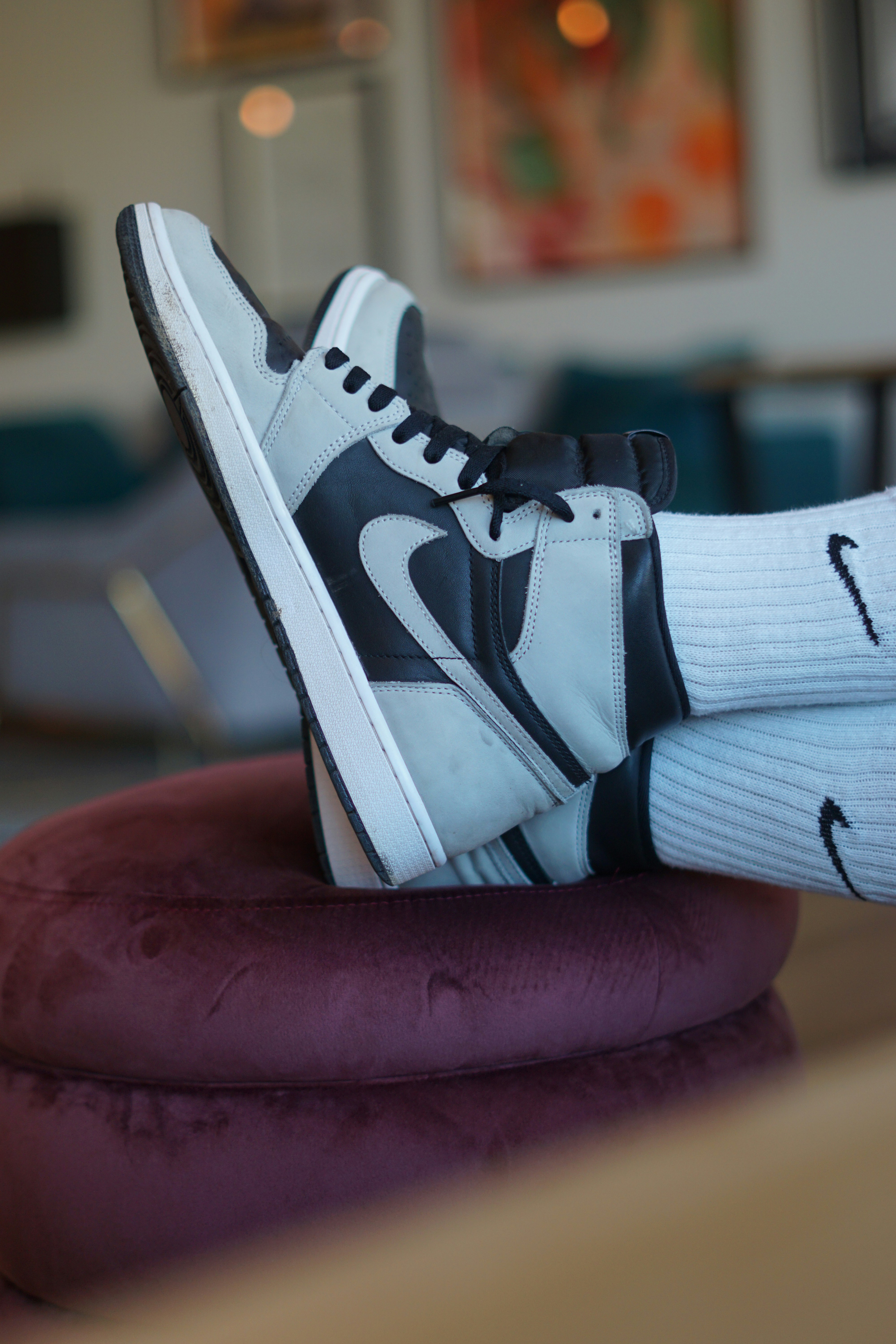 Waiting for the Roll: Sneakers Rest on Velvet Footstool
