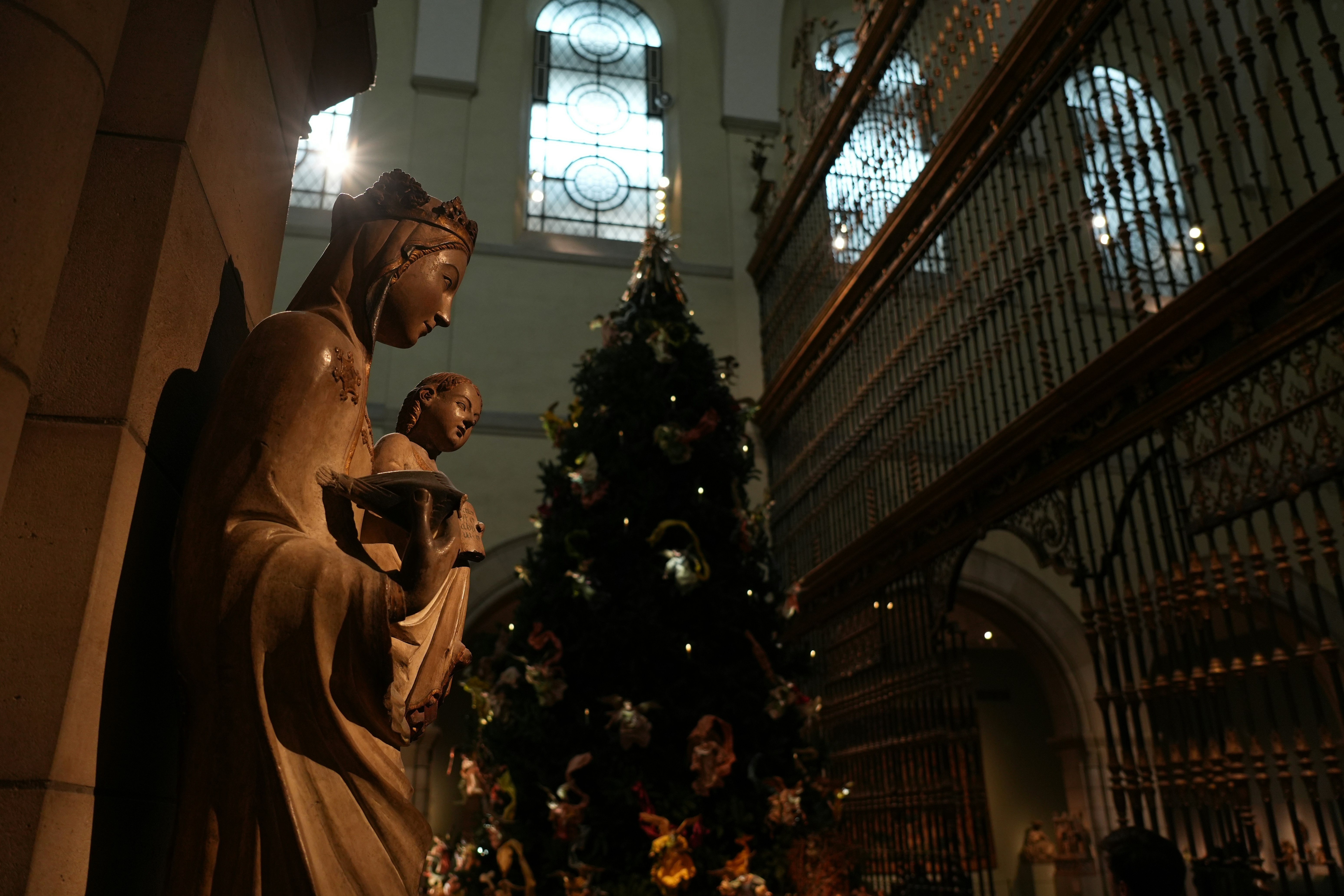 Angelic Carved Figures Beneath a Glowing Christmas Tree