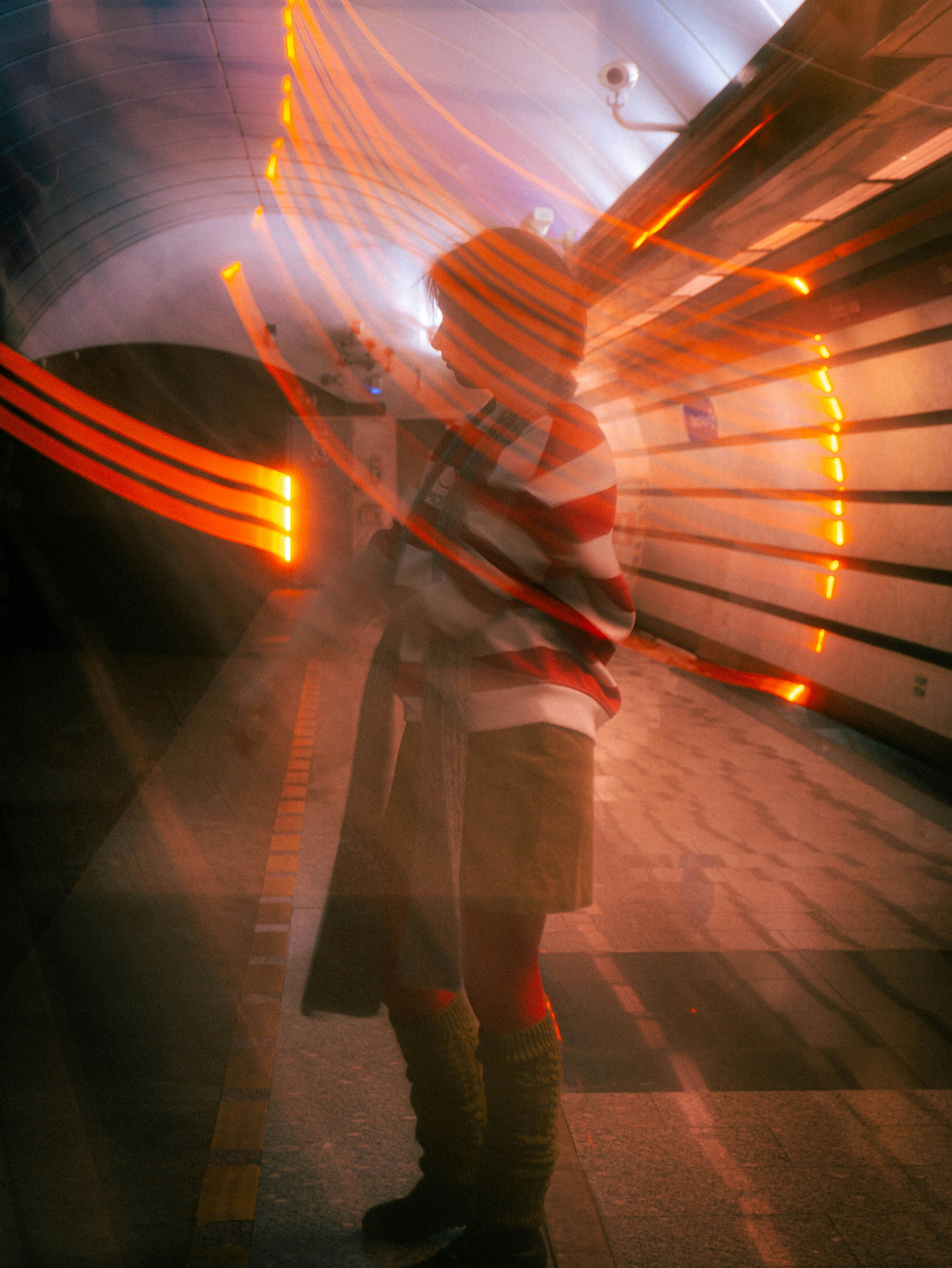 Stripes in Motion: A Blurred Portrait Beneath Neon Arcs