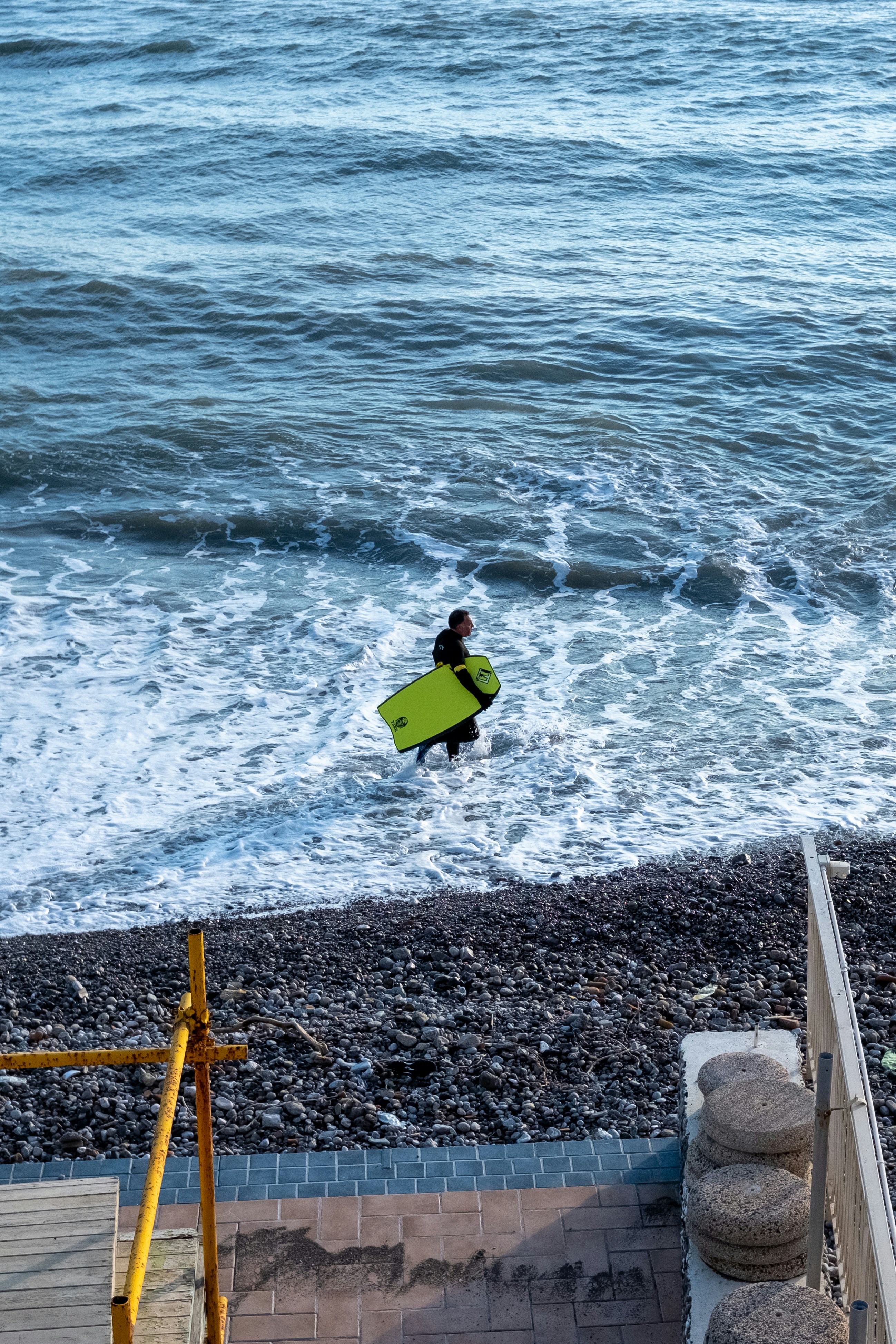 Bright-green Surfboard Rider Emerging from Cresting Wave