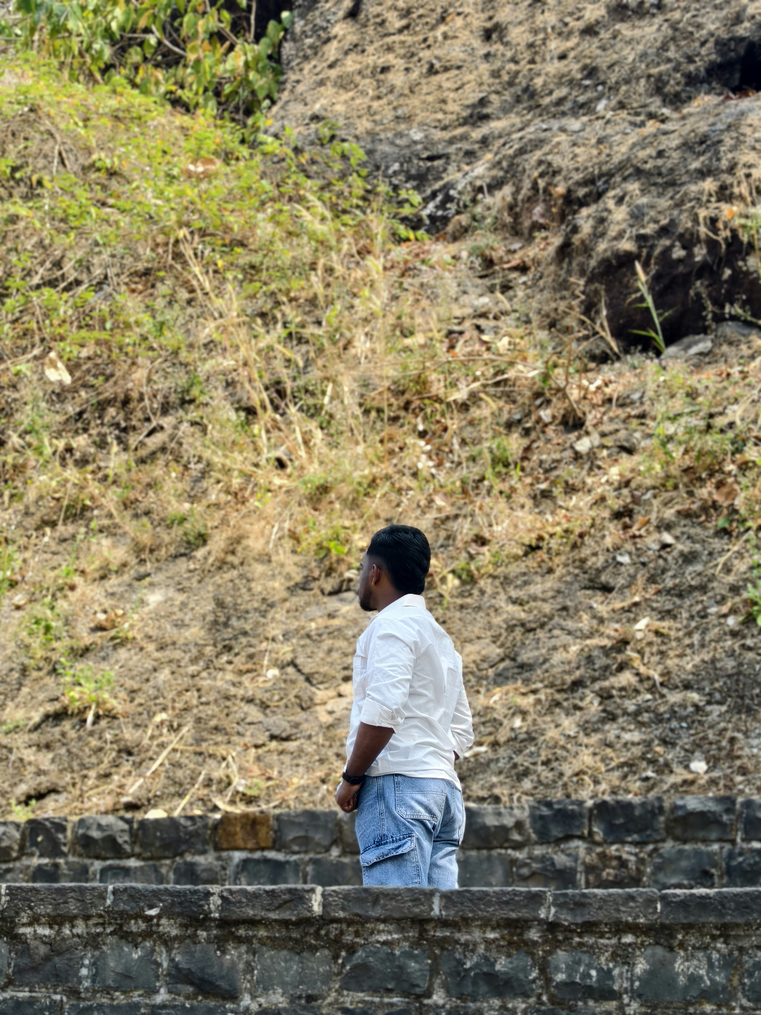 Widowed Stone Staircase and a Man in White Shirt Amid rocky hillside