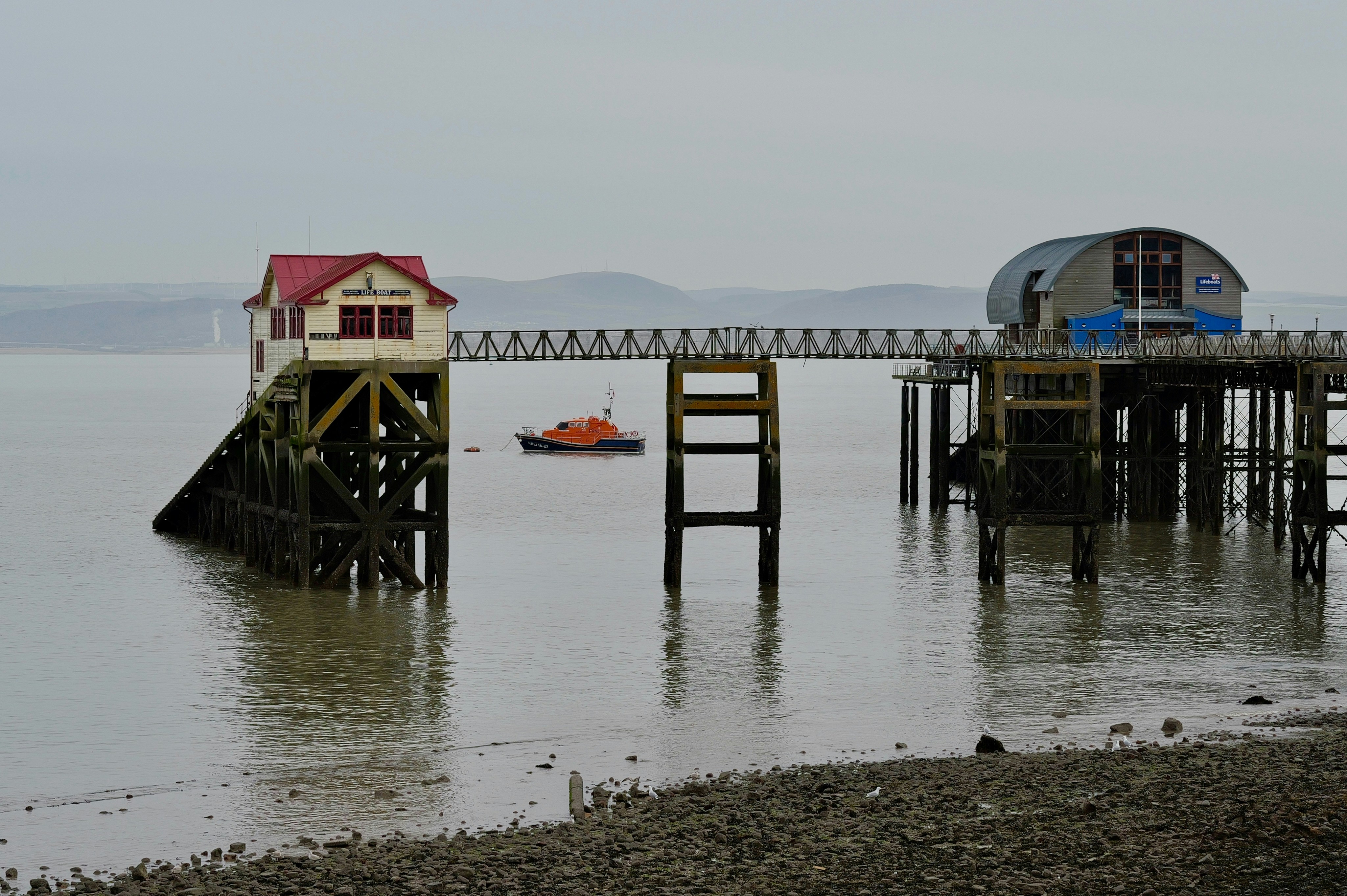 Midst of a Quiet Pier: A Red-roofed Hut and a Small Rescue Boat