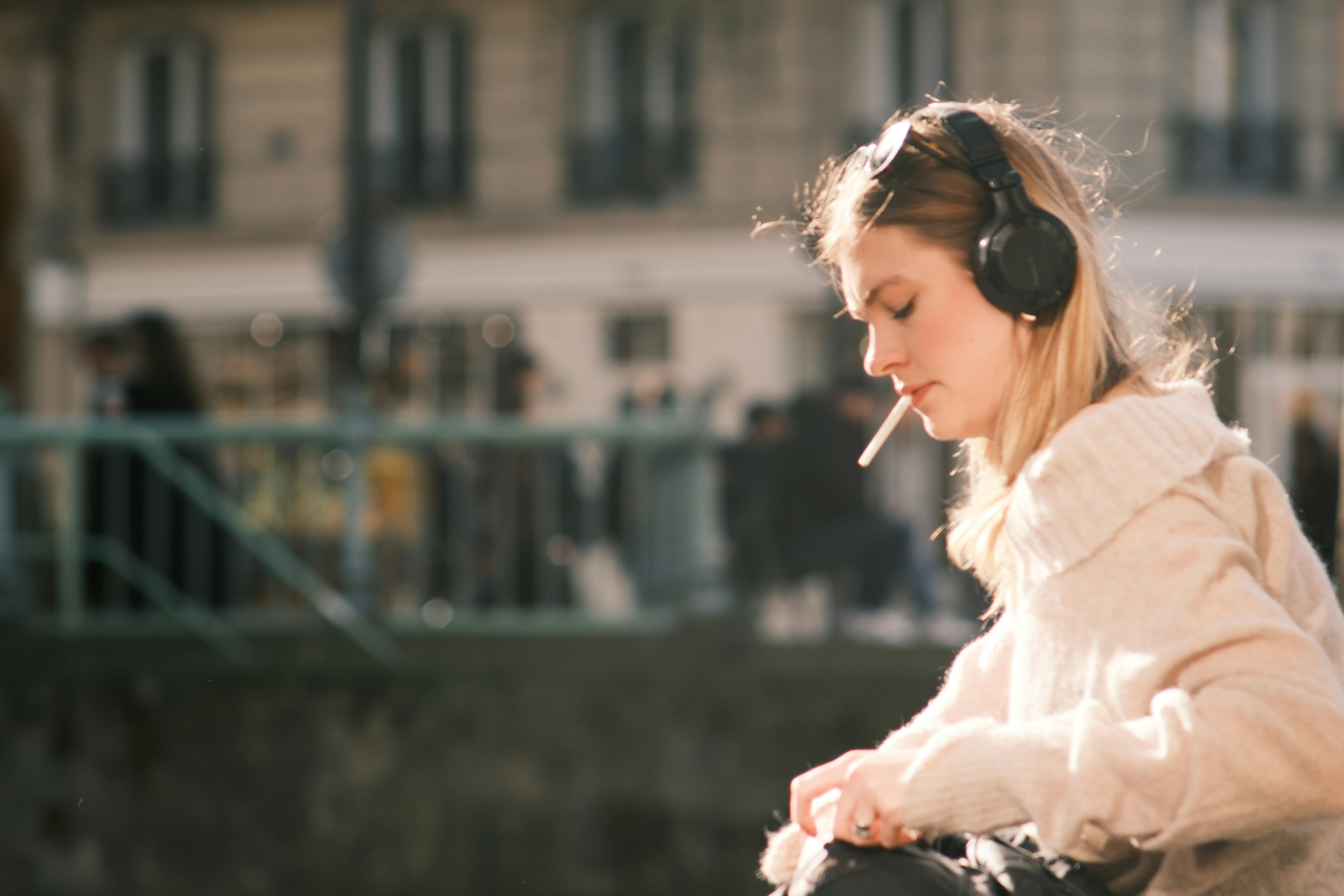 Headphones, Cigarette, and Quiet Focus: A Moment in the Park