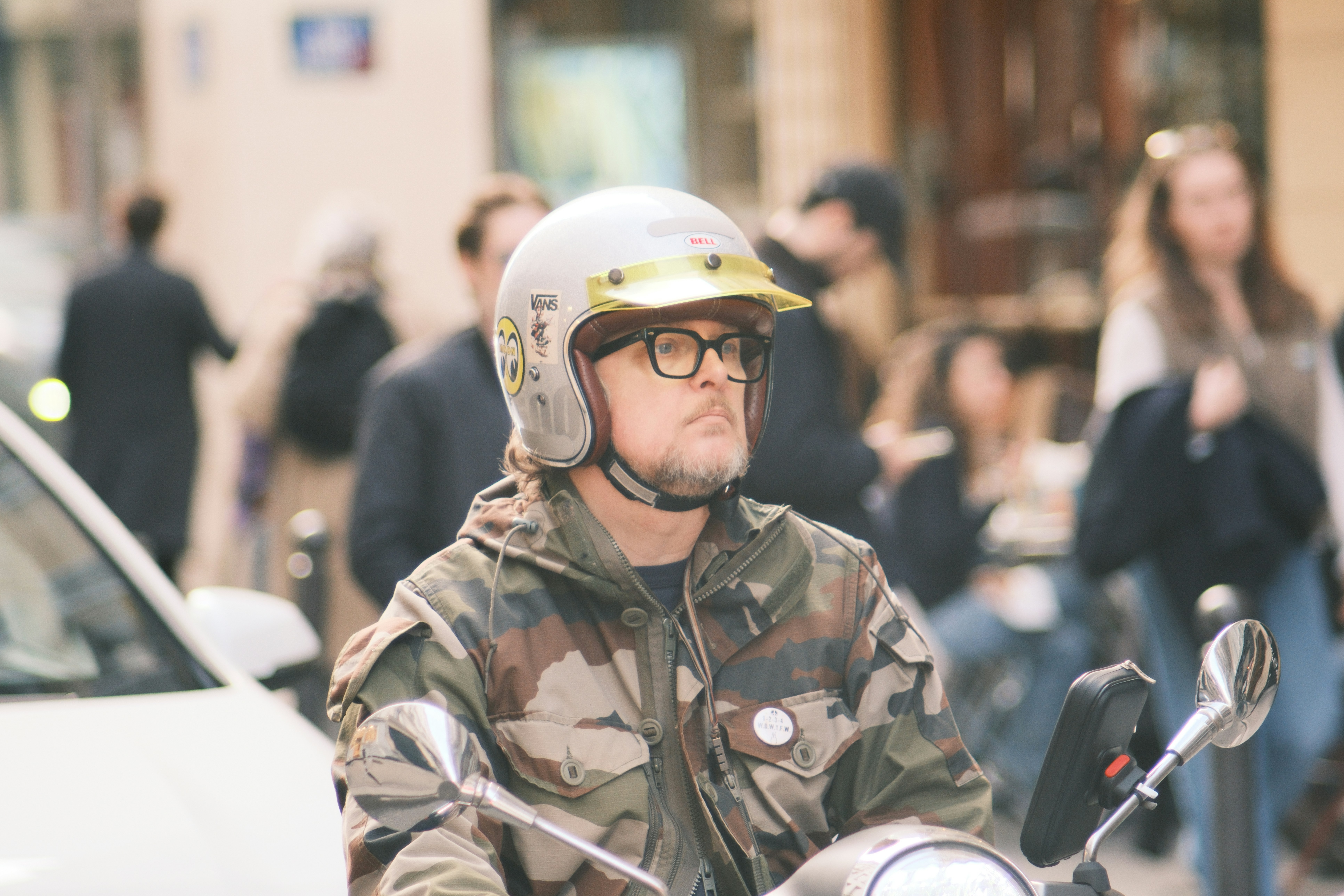 Helmeted Rider in a Bustling Street: Focus in the Moment