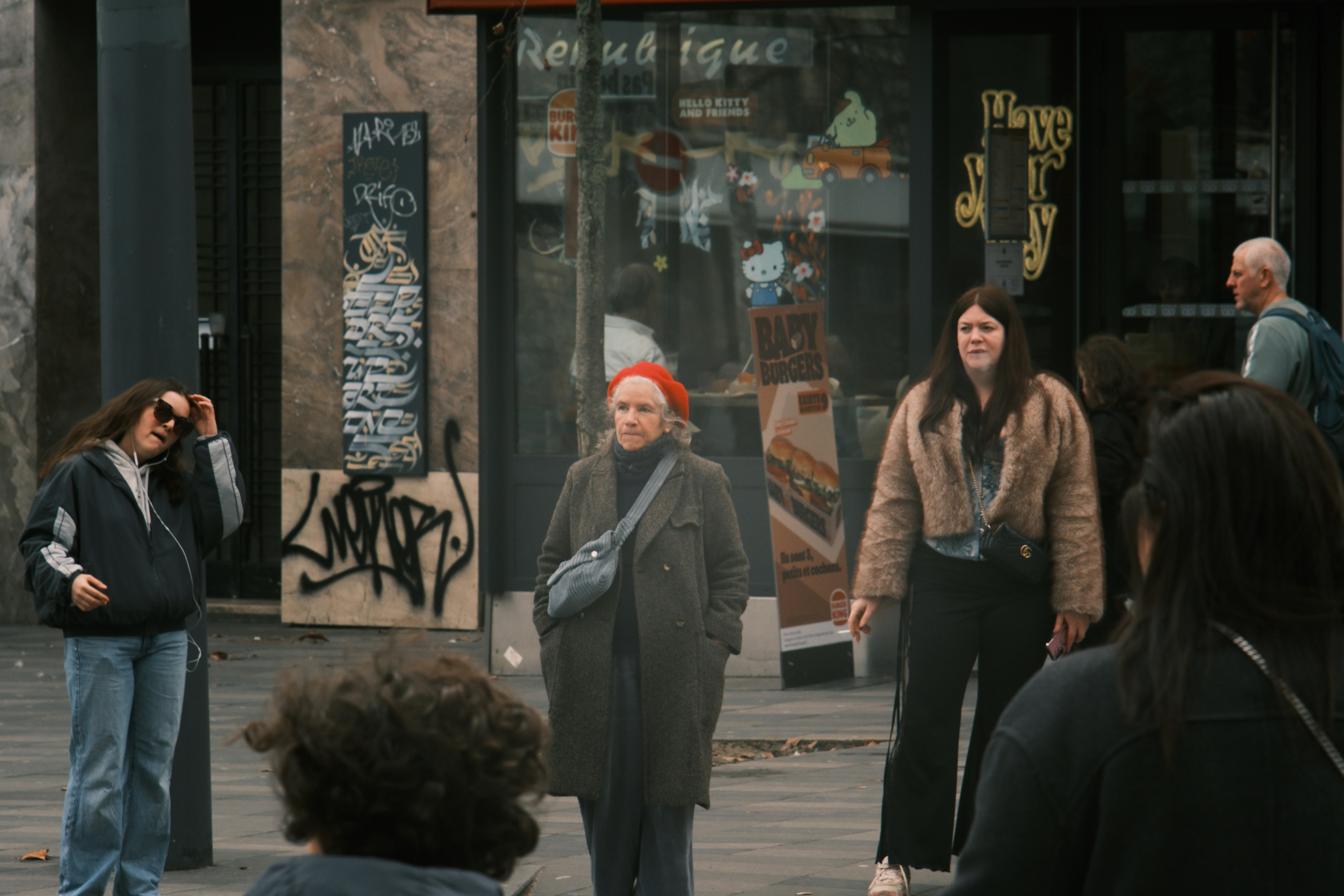 Street Scene: Quiet Conversation Under Graffiti and Glass