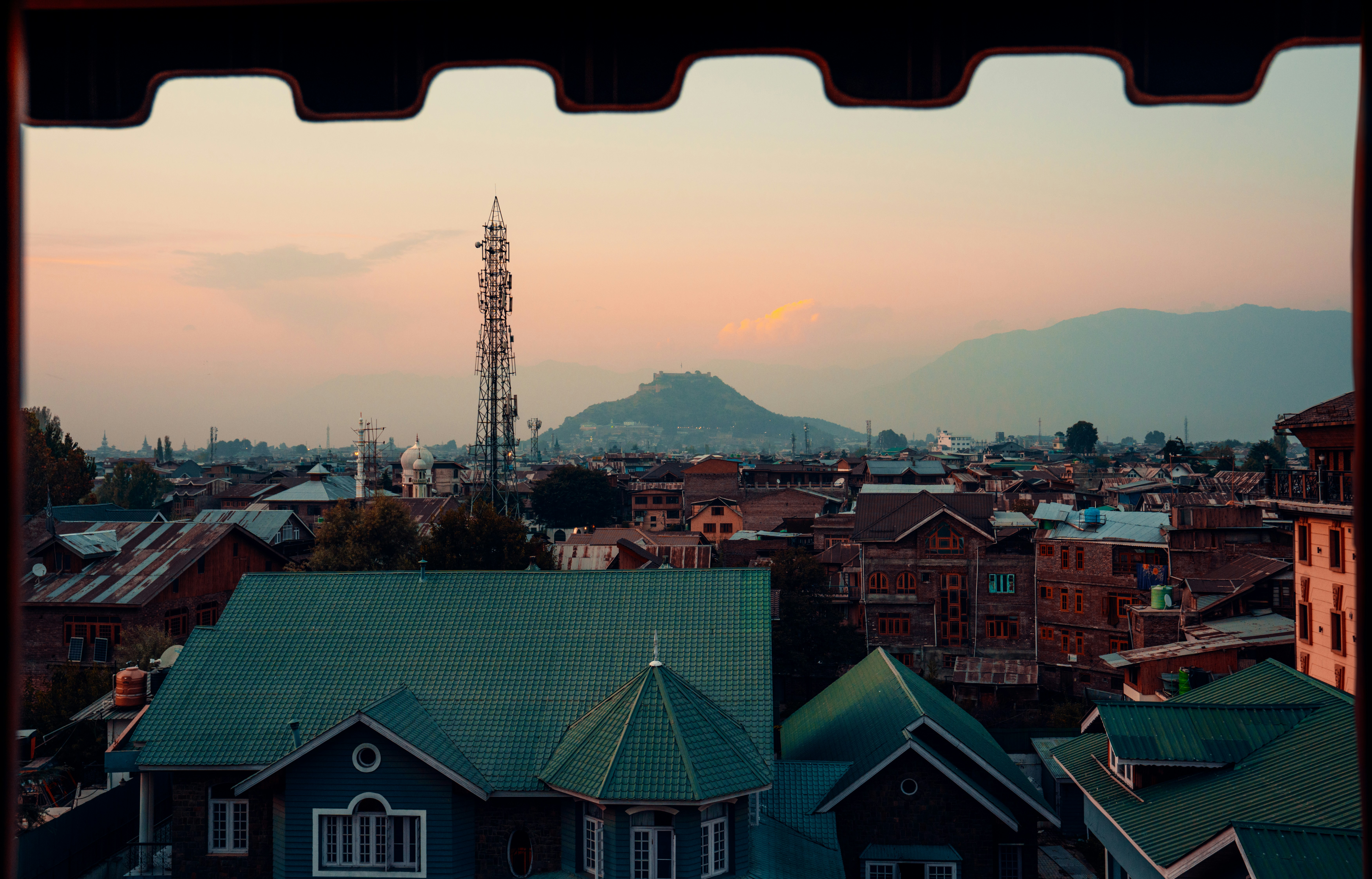 Distant City Rooftops Under a Soft Dusk Sky