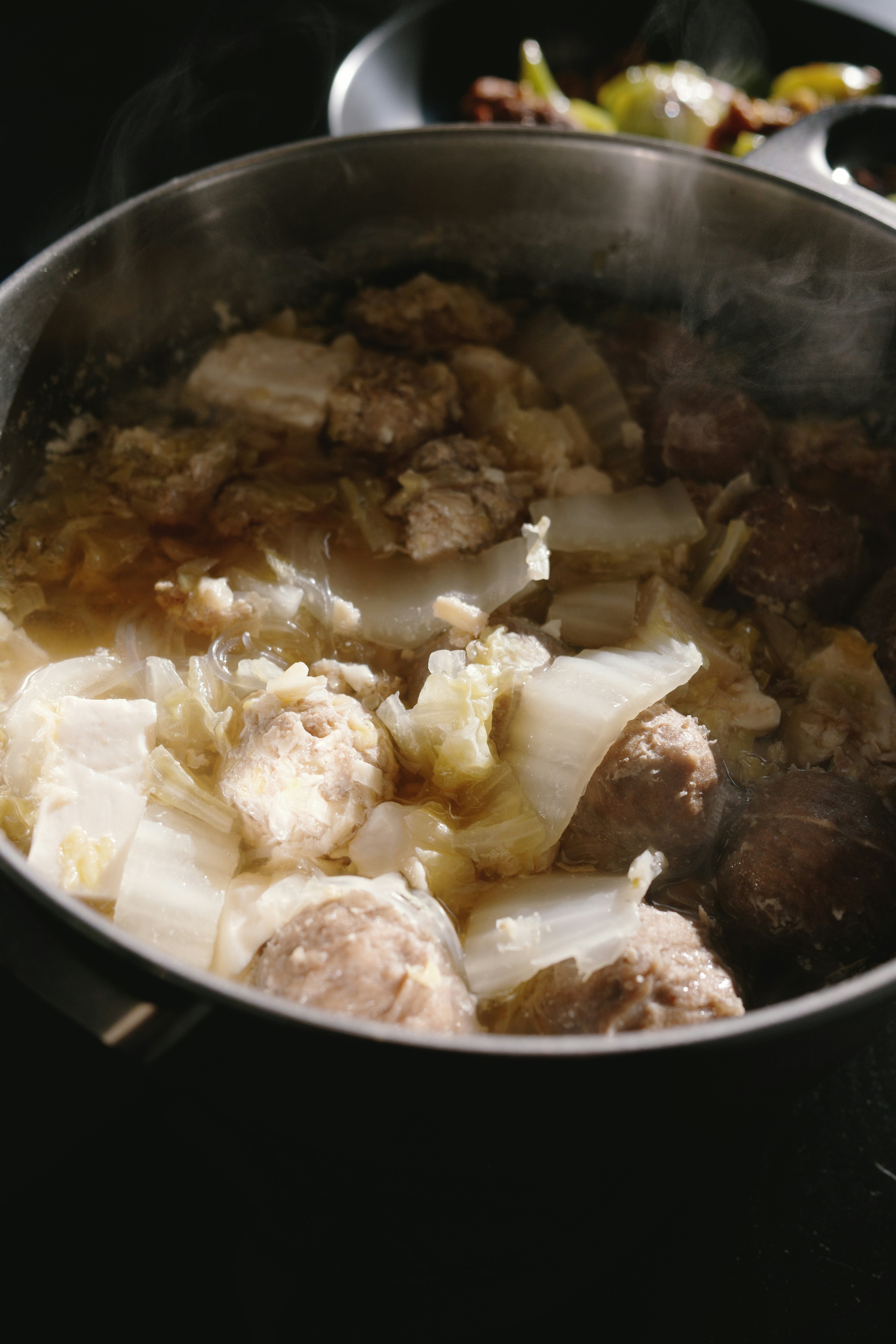 Meatballs and cabbage simmering in a pot