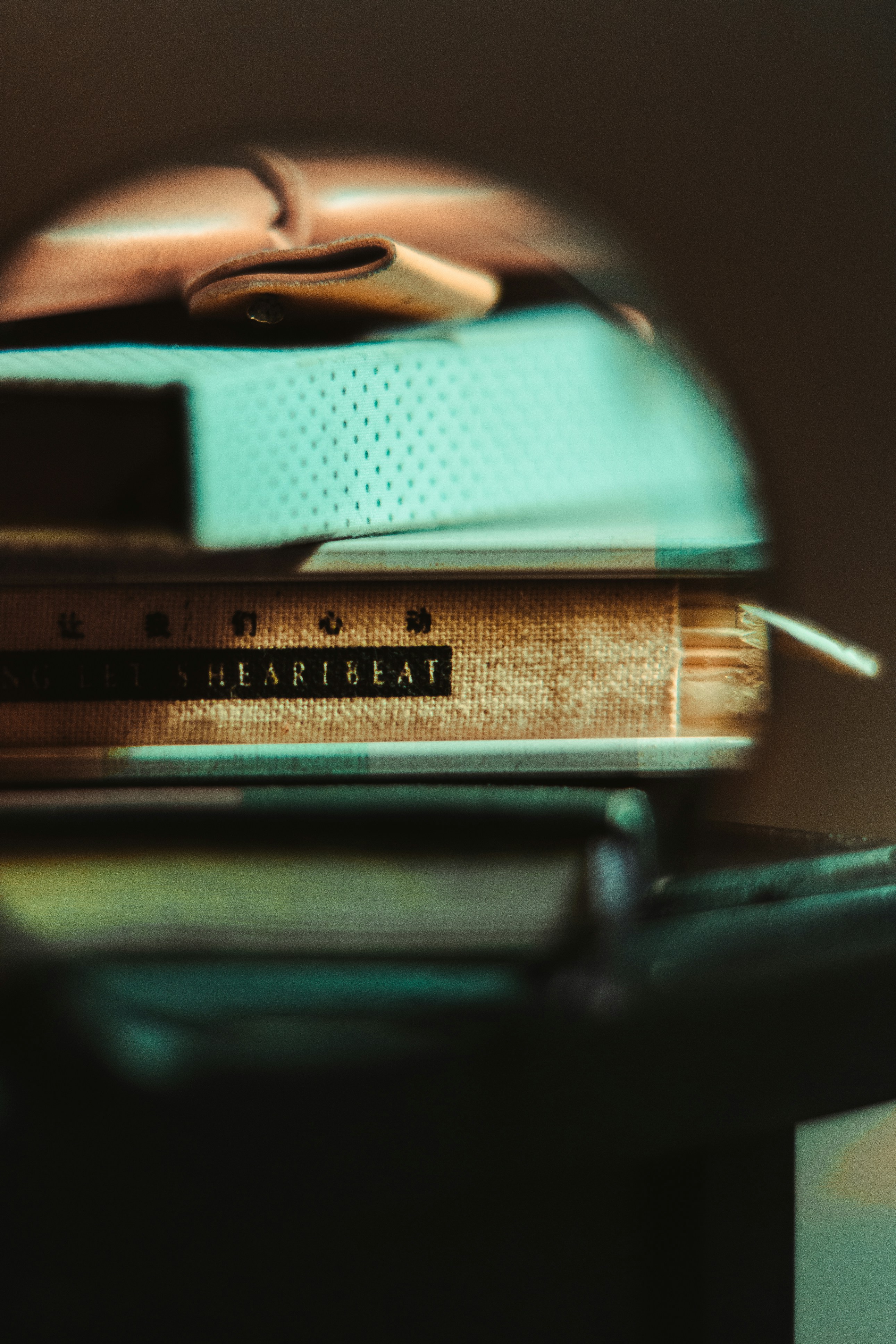 Macro view through a lens: stacked vintage cassette and mint case under soft focus