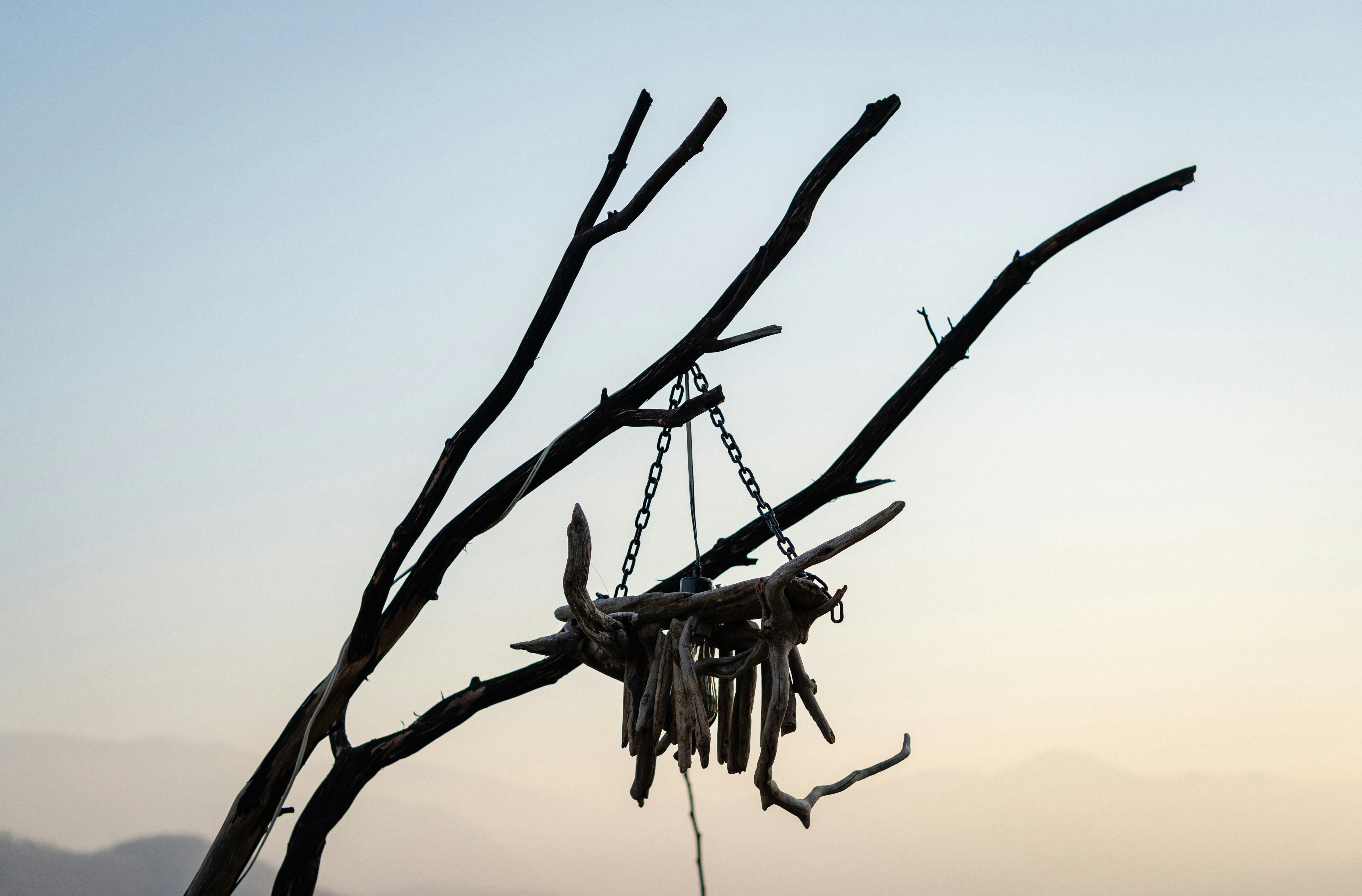 Hanging Drift: Weathered Wood and Chains at Dusk