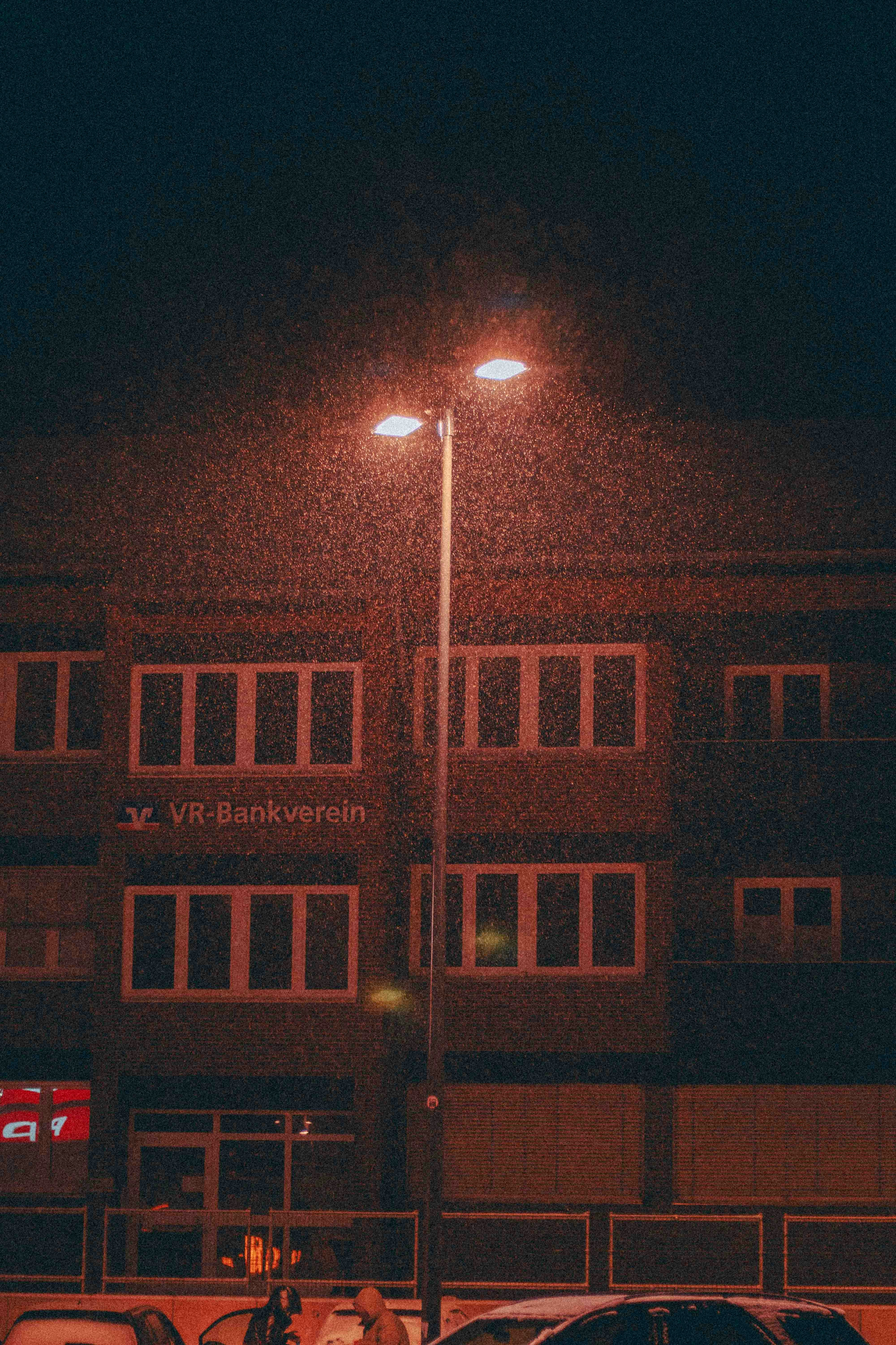 Night Streetlight Silhouette over a Quiet Building