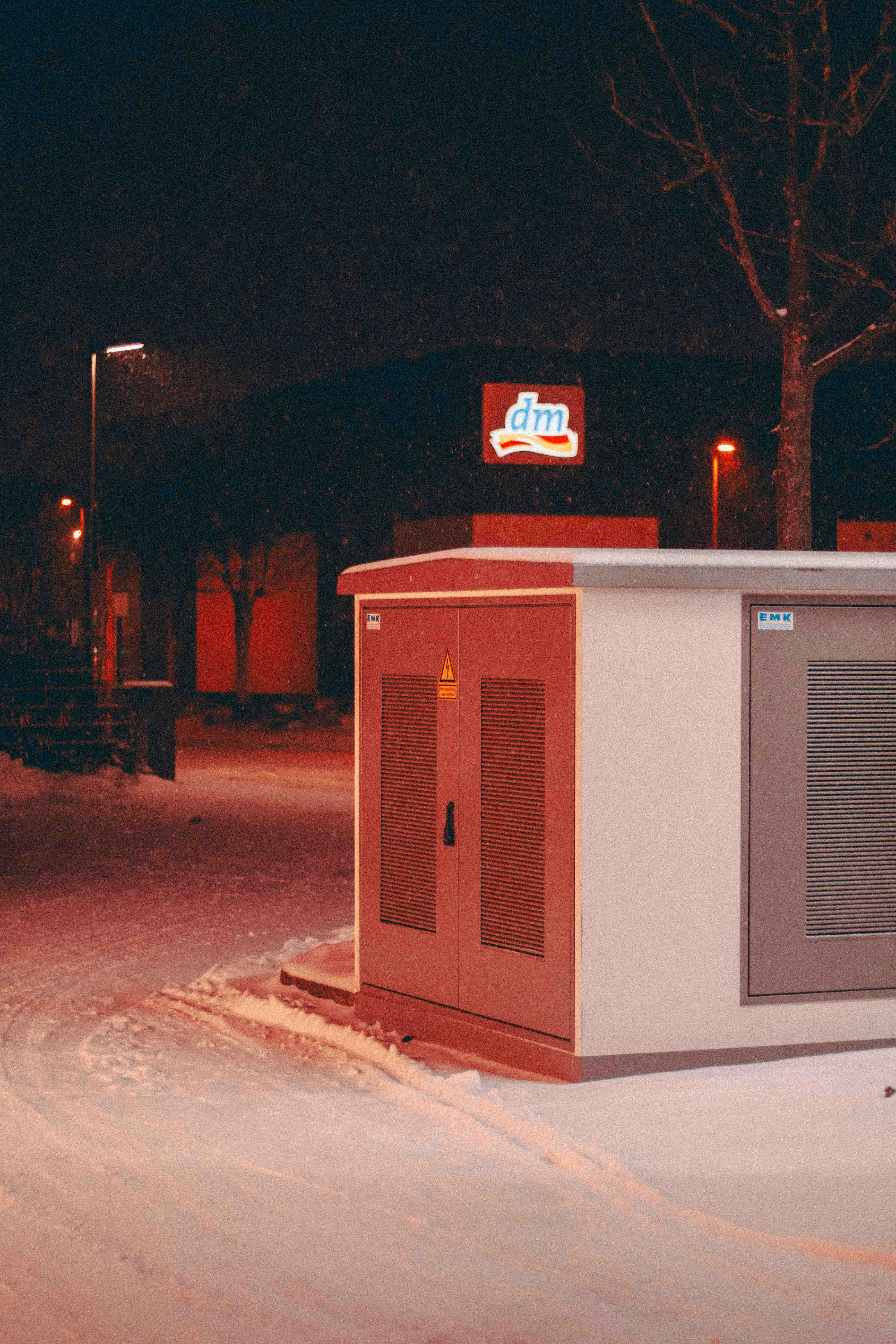 Night at the DM Store: Snow-Soft Neon and a Stationary Utility