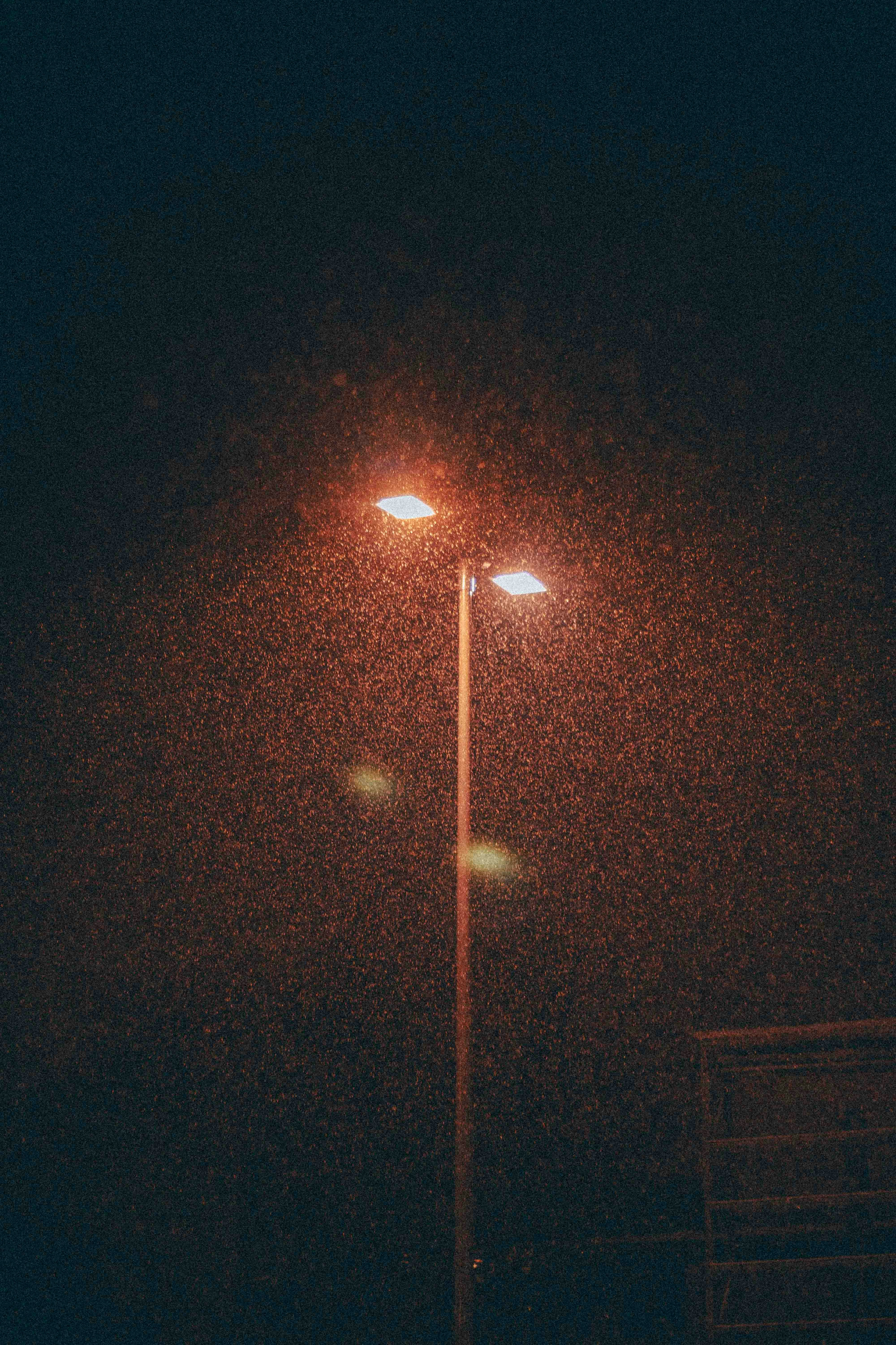 Night Lanterns in Snow: A Quiet Streetlamp Glow Through Falling Snow